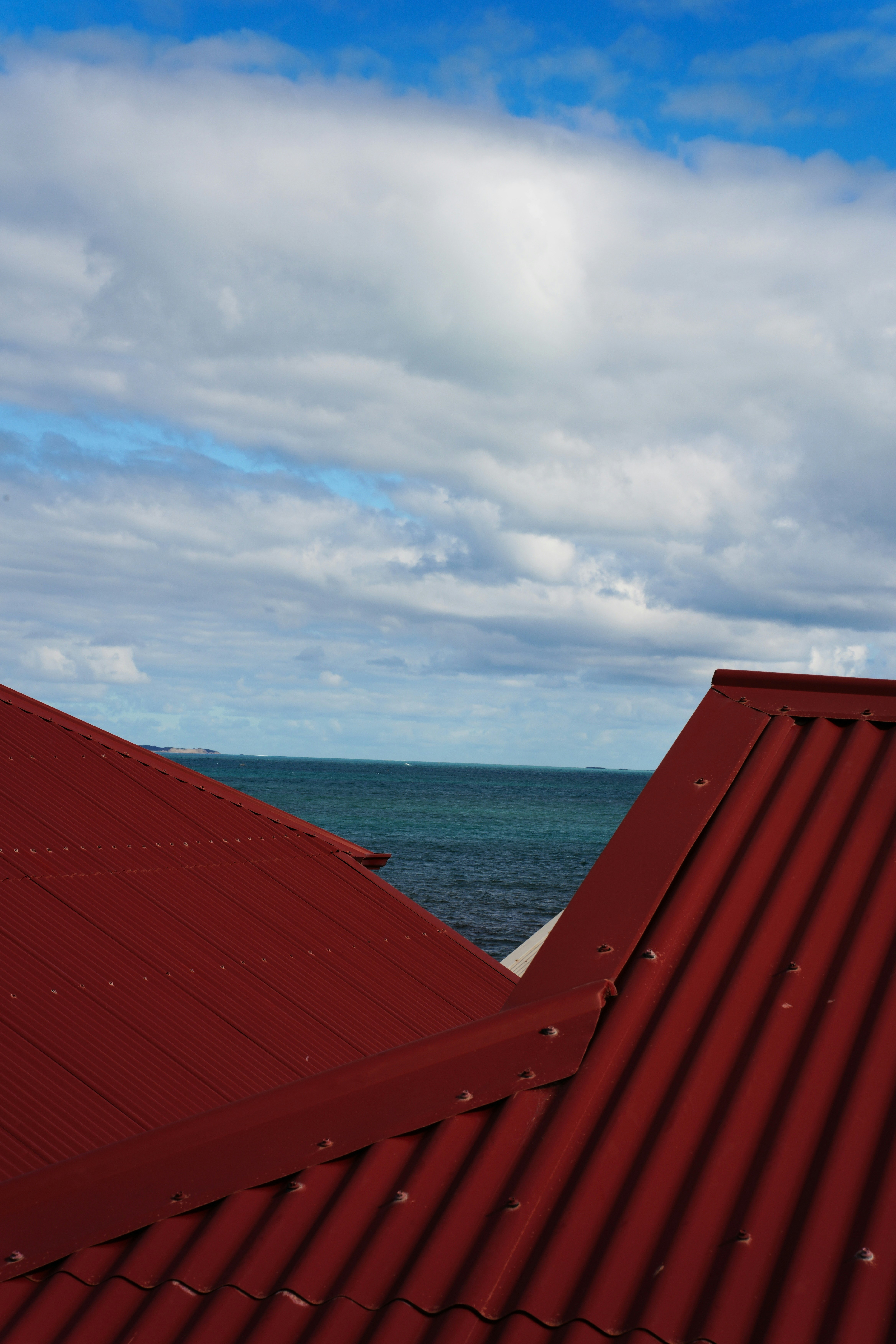 Red Roofs Framing a Sea View