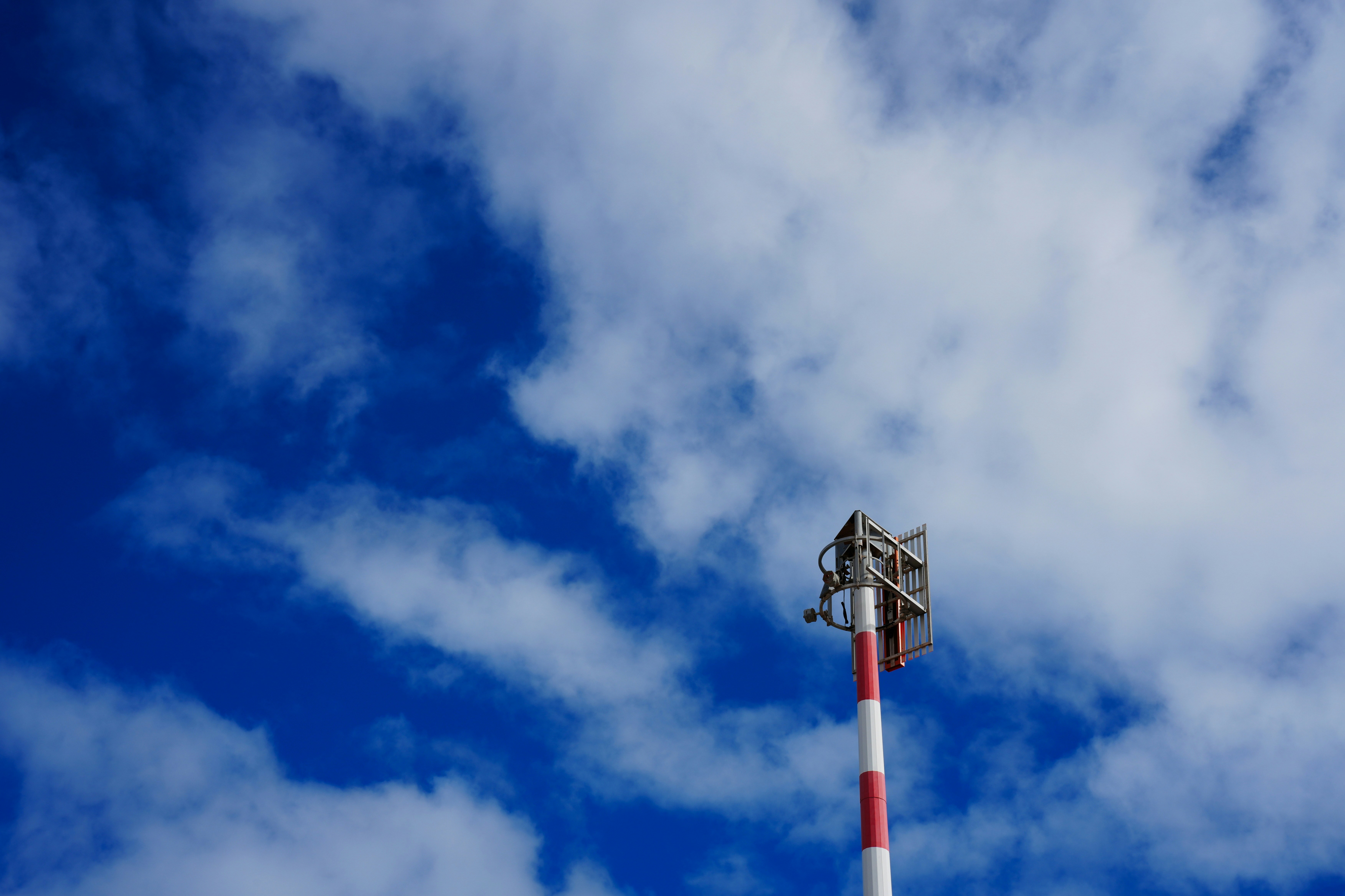 Skyward Signal: A Striped Mast Reaching into the Blue