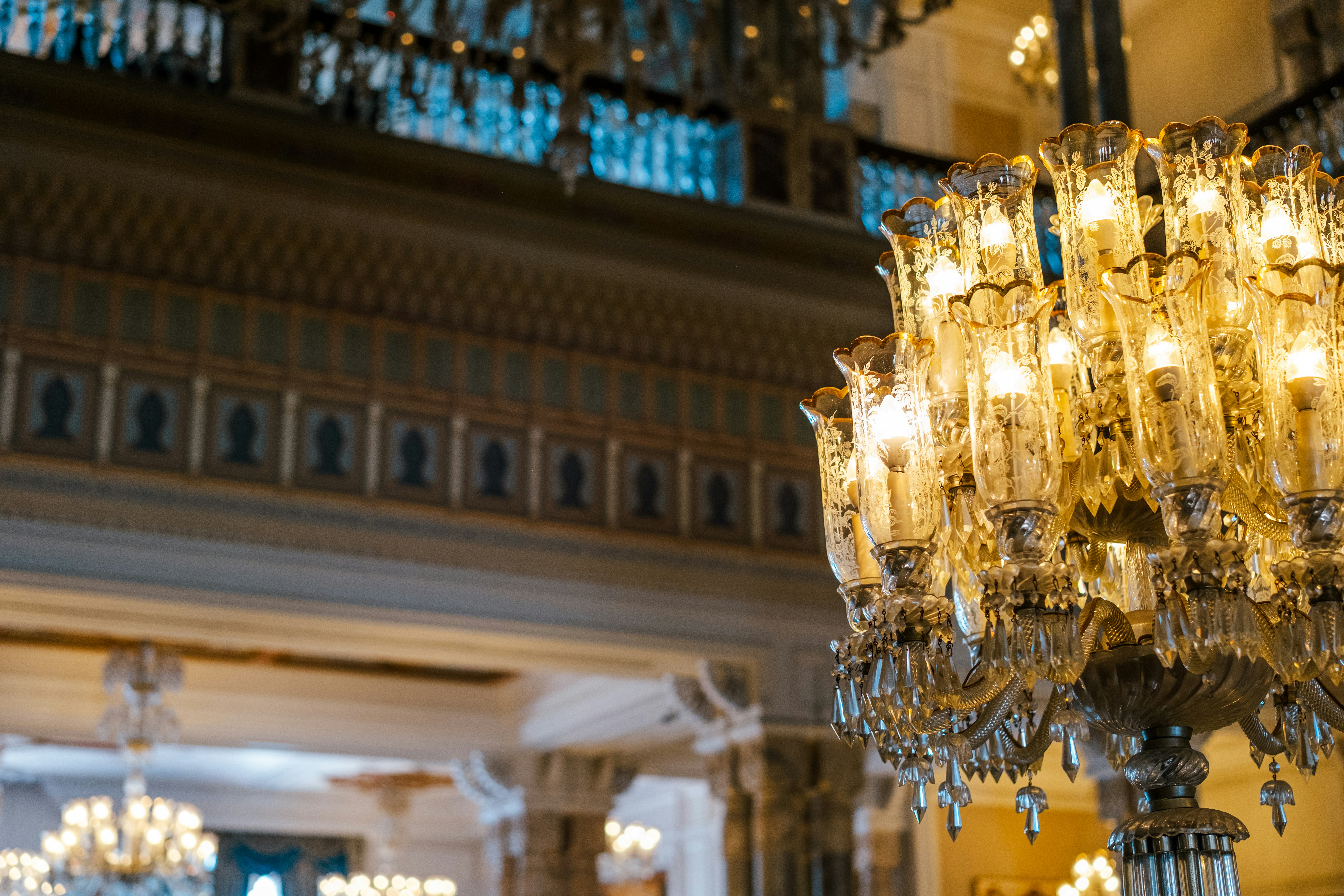 Crystal Crown: A Close-Up of Opulent Chandeliers in a Grand Hall
