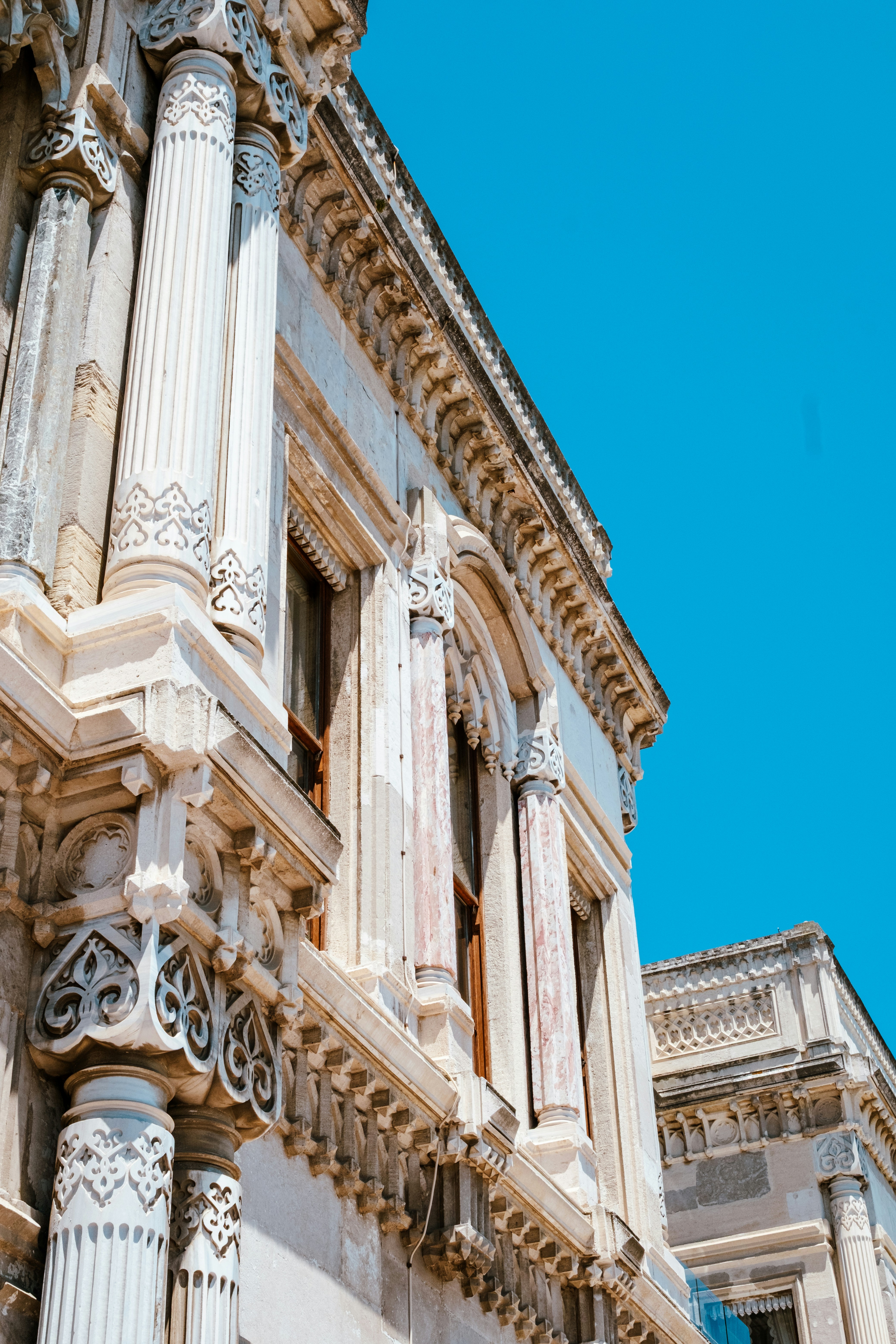 Ornate Archway in Sunlit Marble Facade