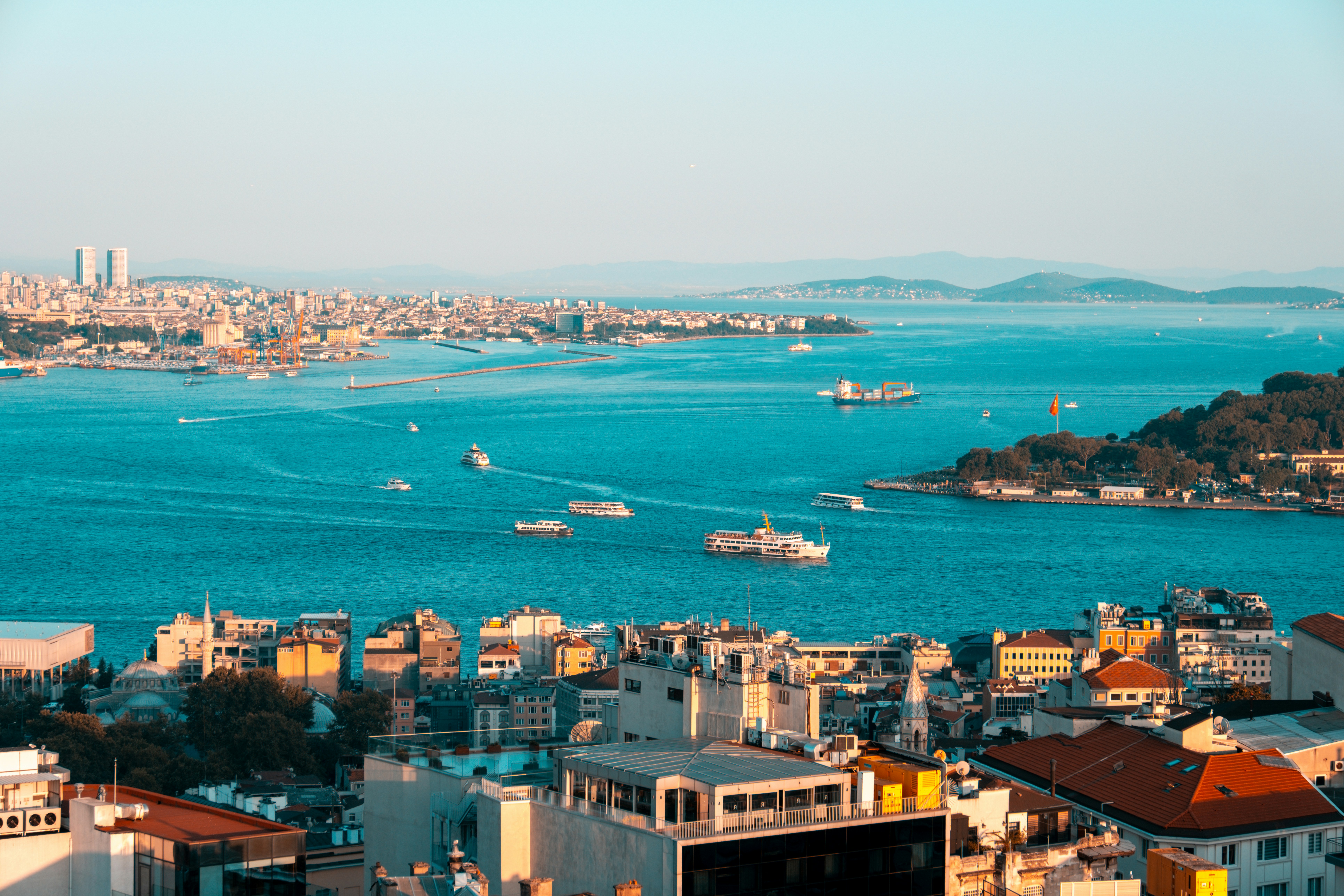Harbor Panorama: Light, Looming Waves, and a Sea of Rooftops