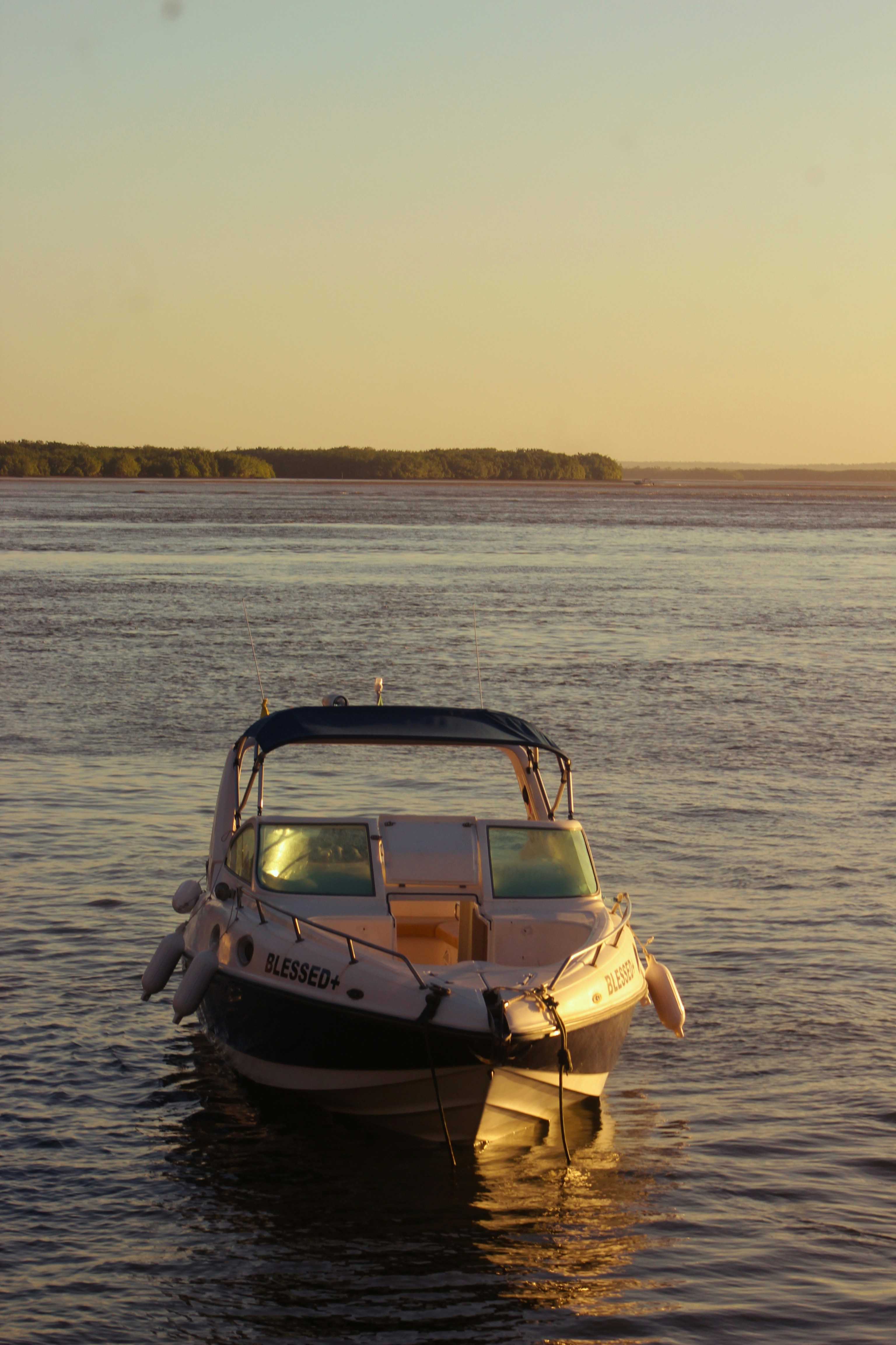 Docked Dream: A Boat Resting in Quiet Sunset Waters