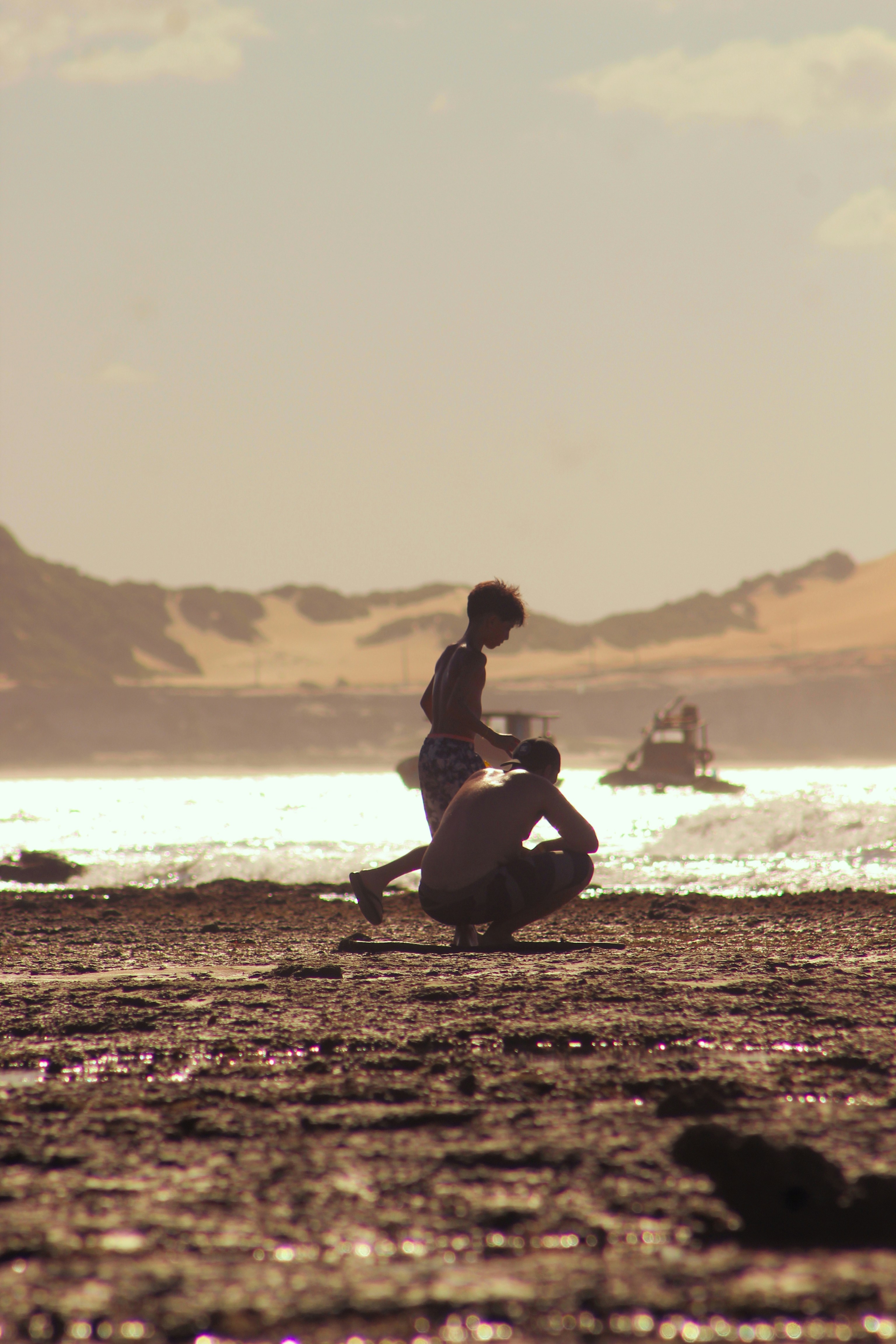 Silhouetted Moment: Father and Son on a Sunset Beach