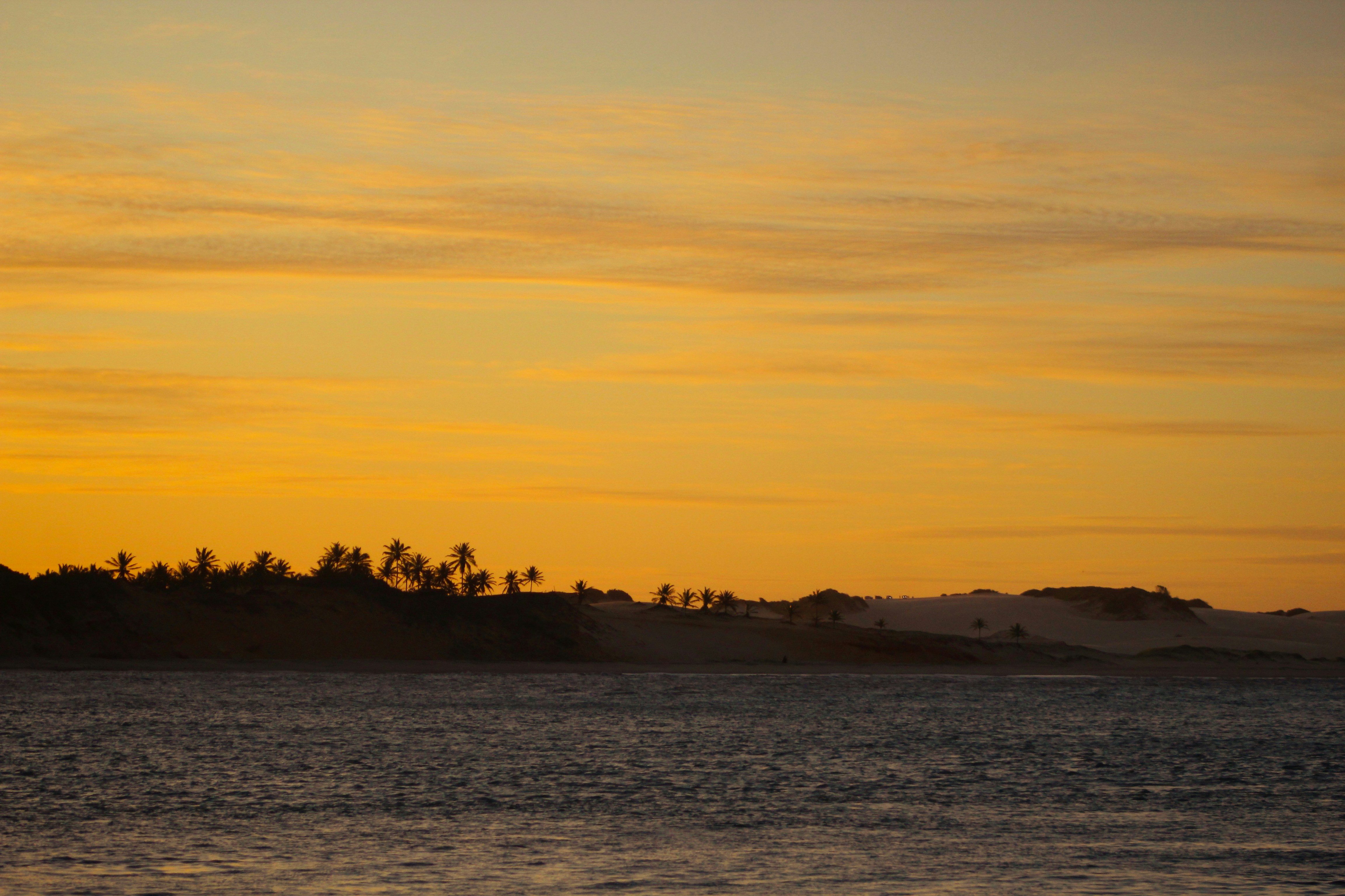 Golden Horizon Over Quiet Coastal Waters At Dusk