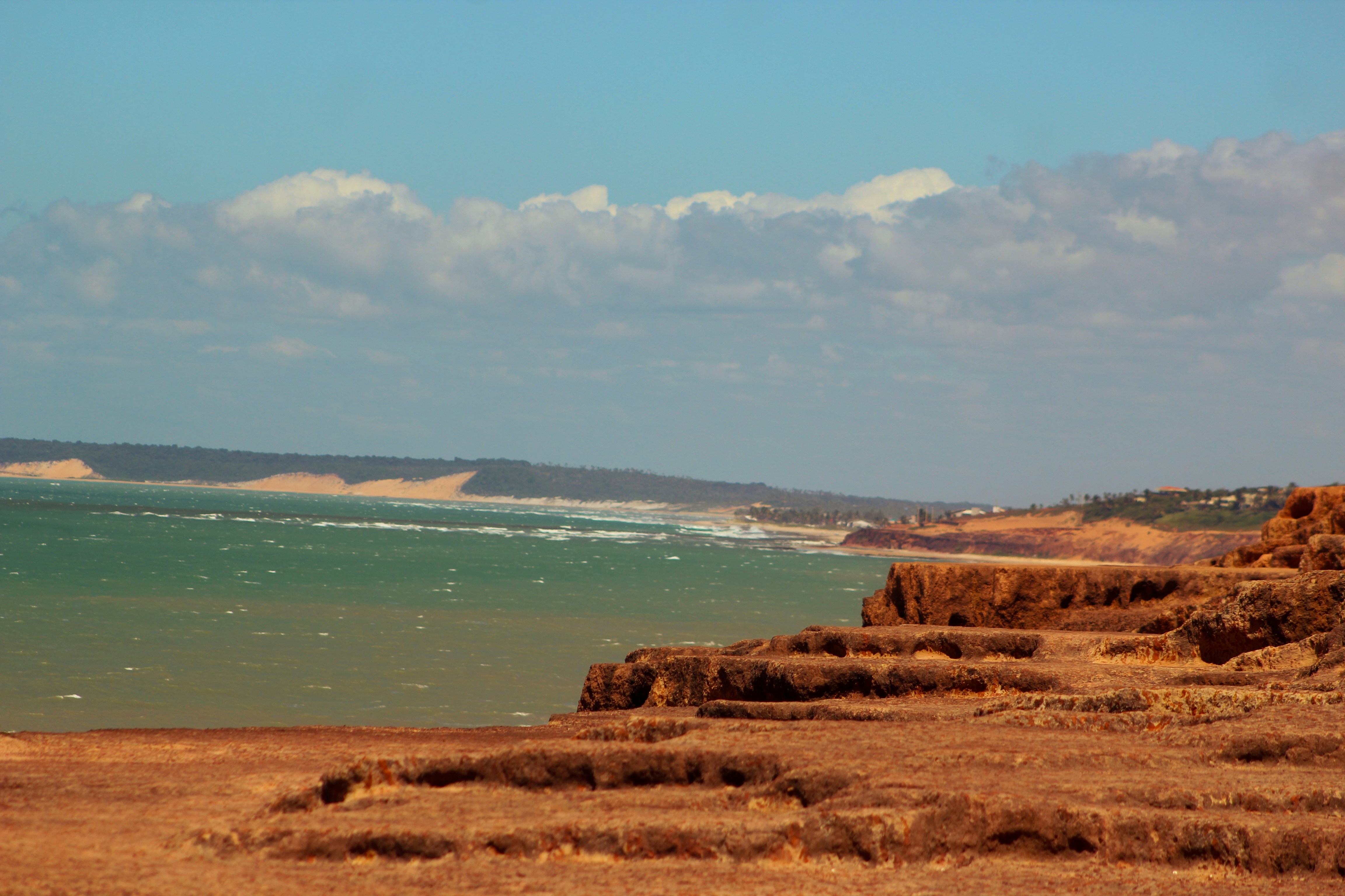 Sunlit Red Cliffs by a Quiet Sea
