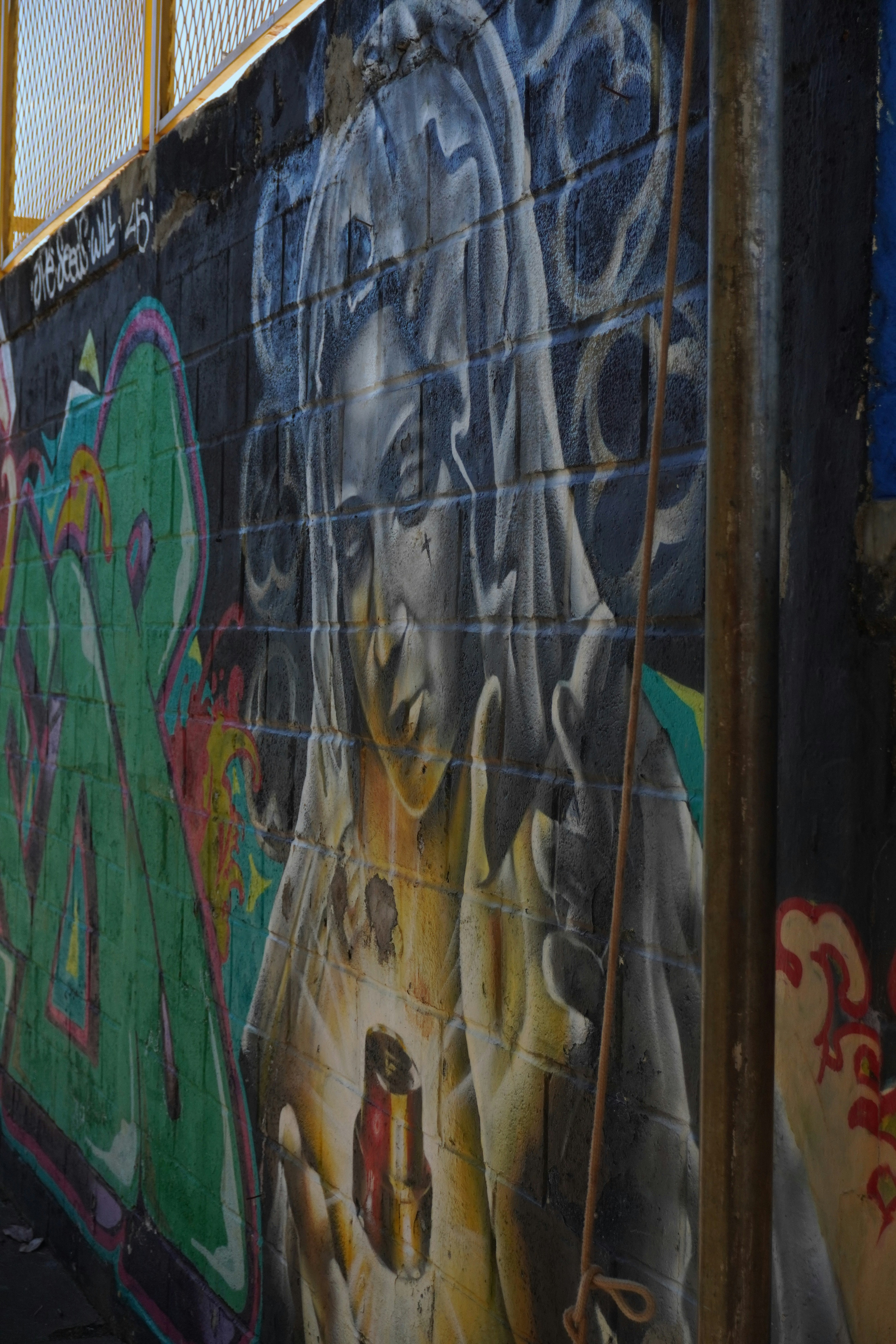 Mural Portrait of a Woman Emerging from Graffiti Wake on a Brick Wall