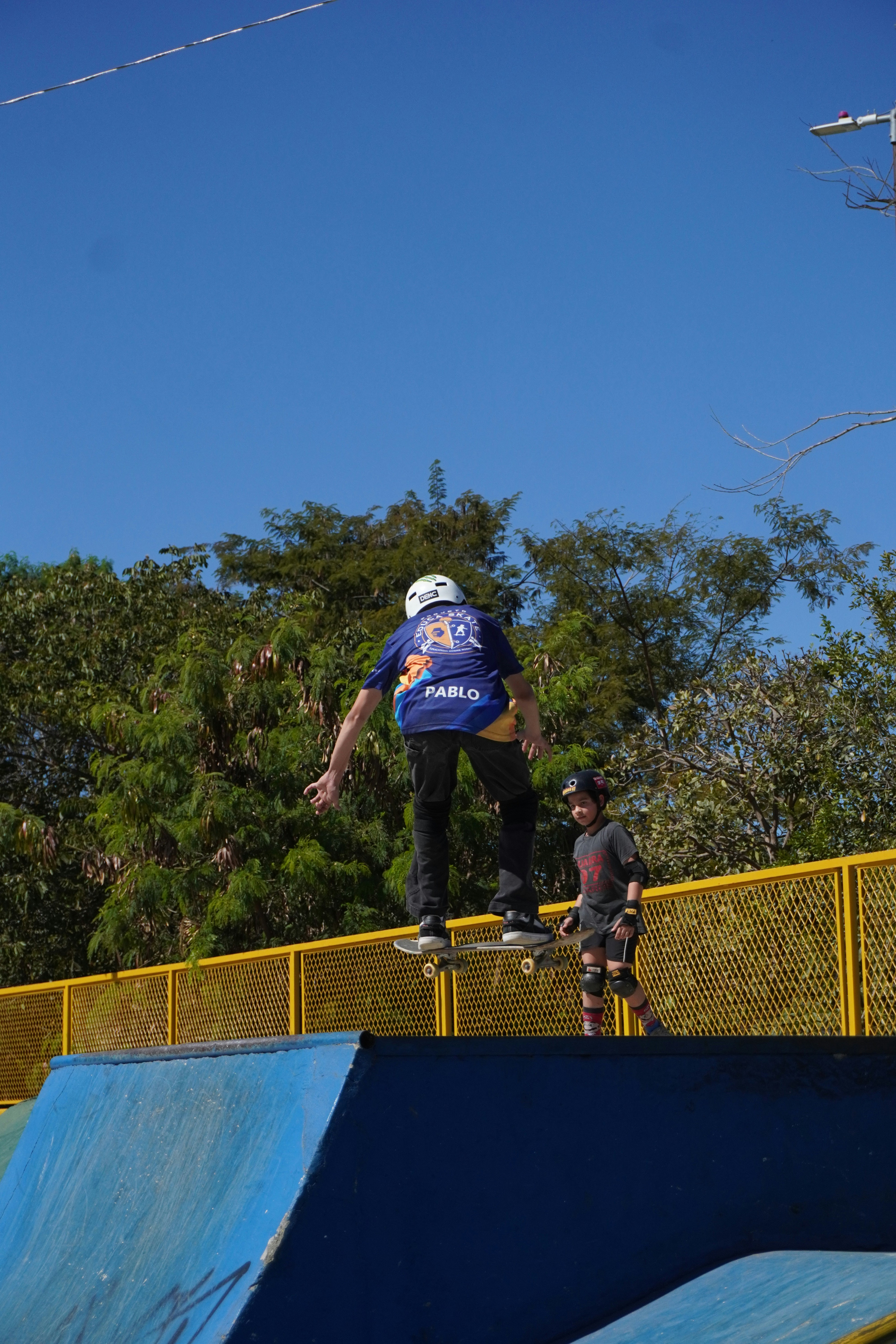Skater in Midair: A Jump Over the Blue Ramp