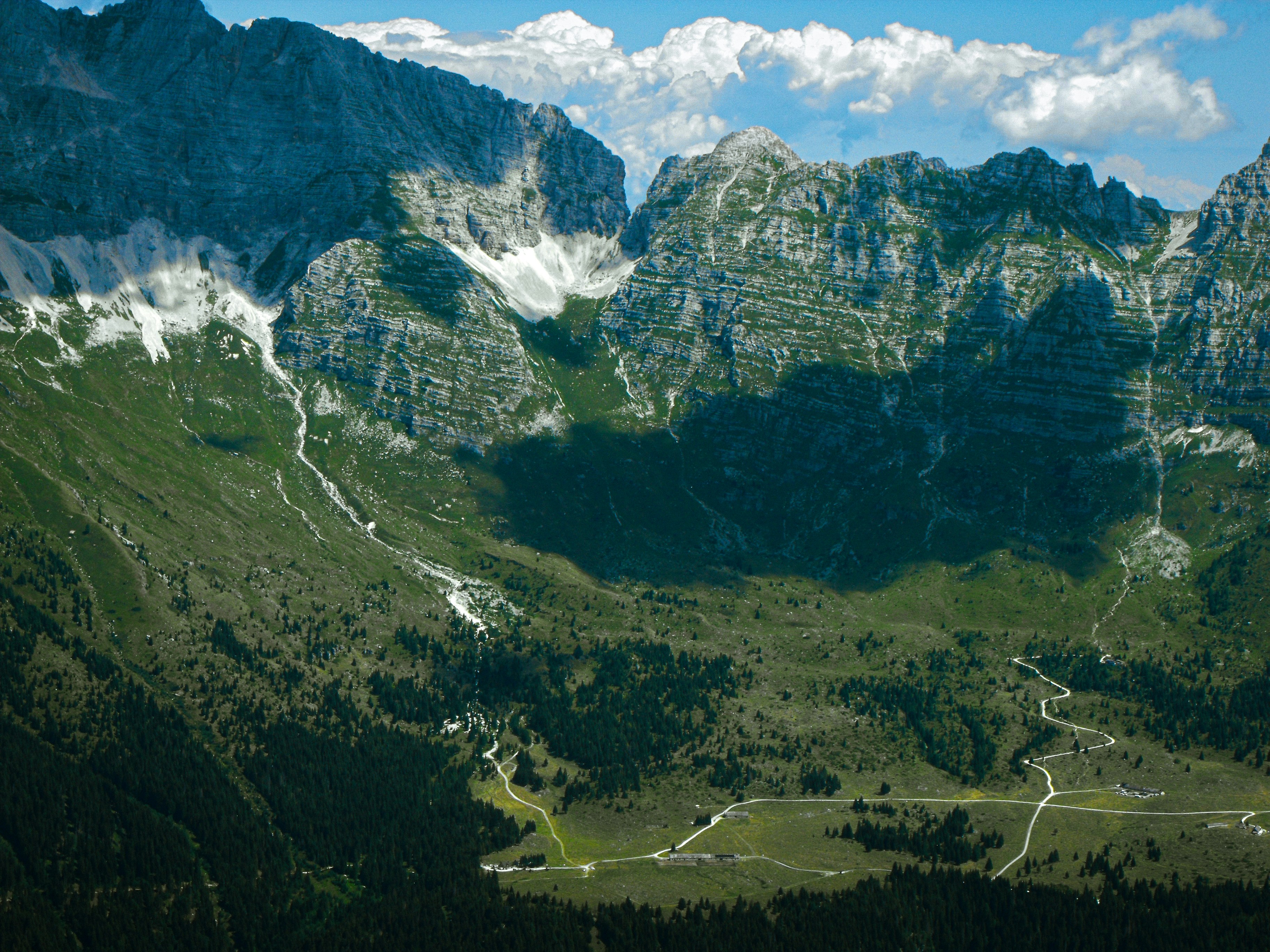 Majestic mountains with green valleys and a winding road.