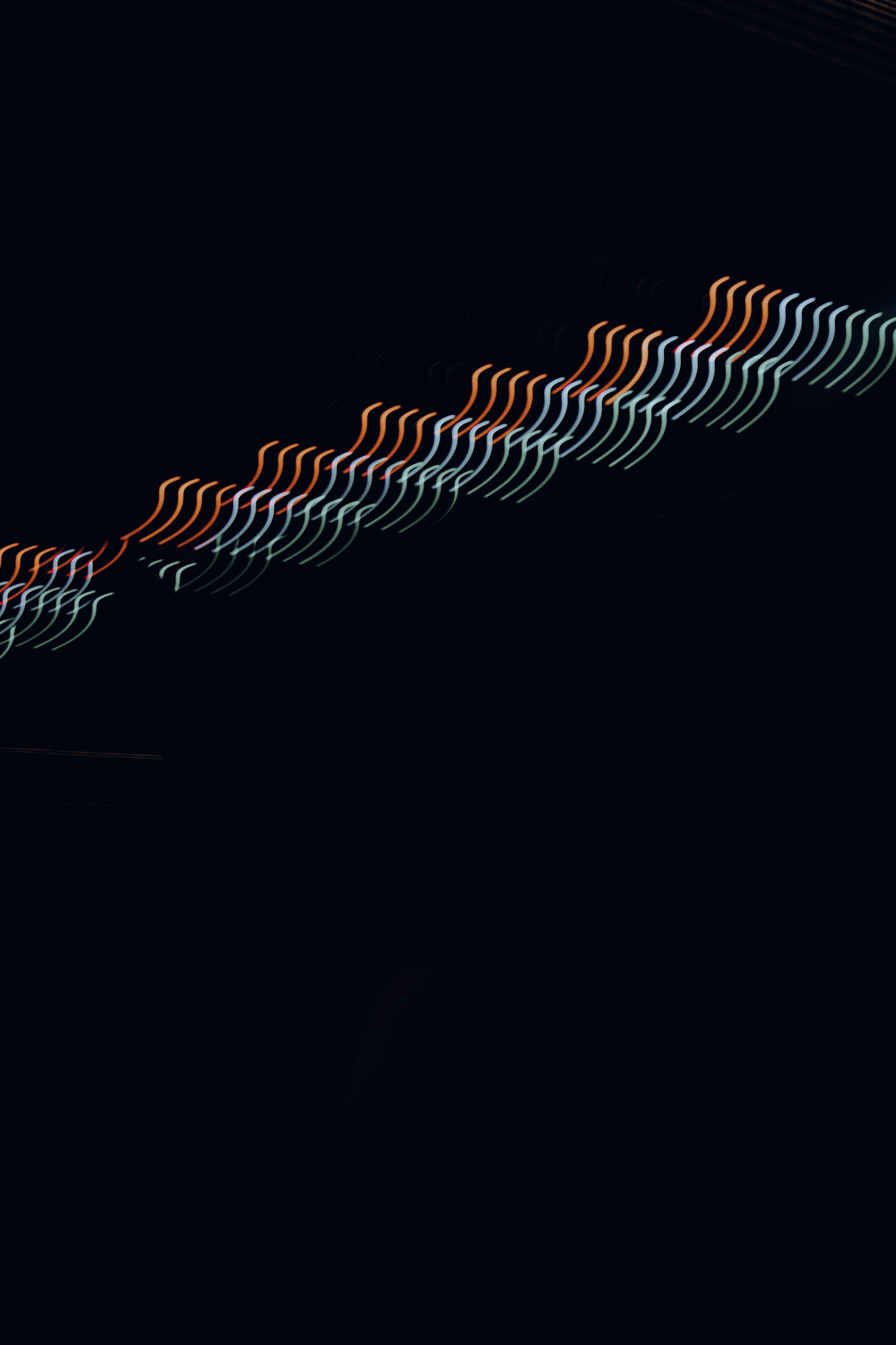Rhythmic Light Trails Across a Midnight Backdrop