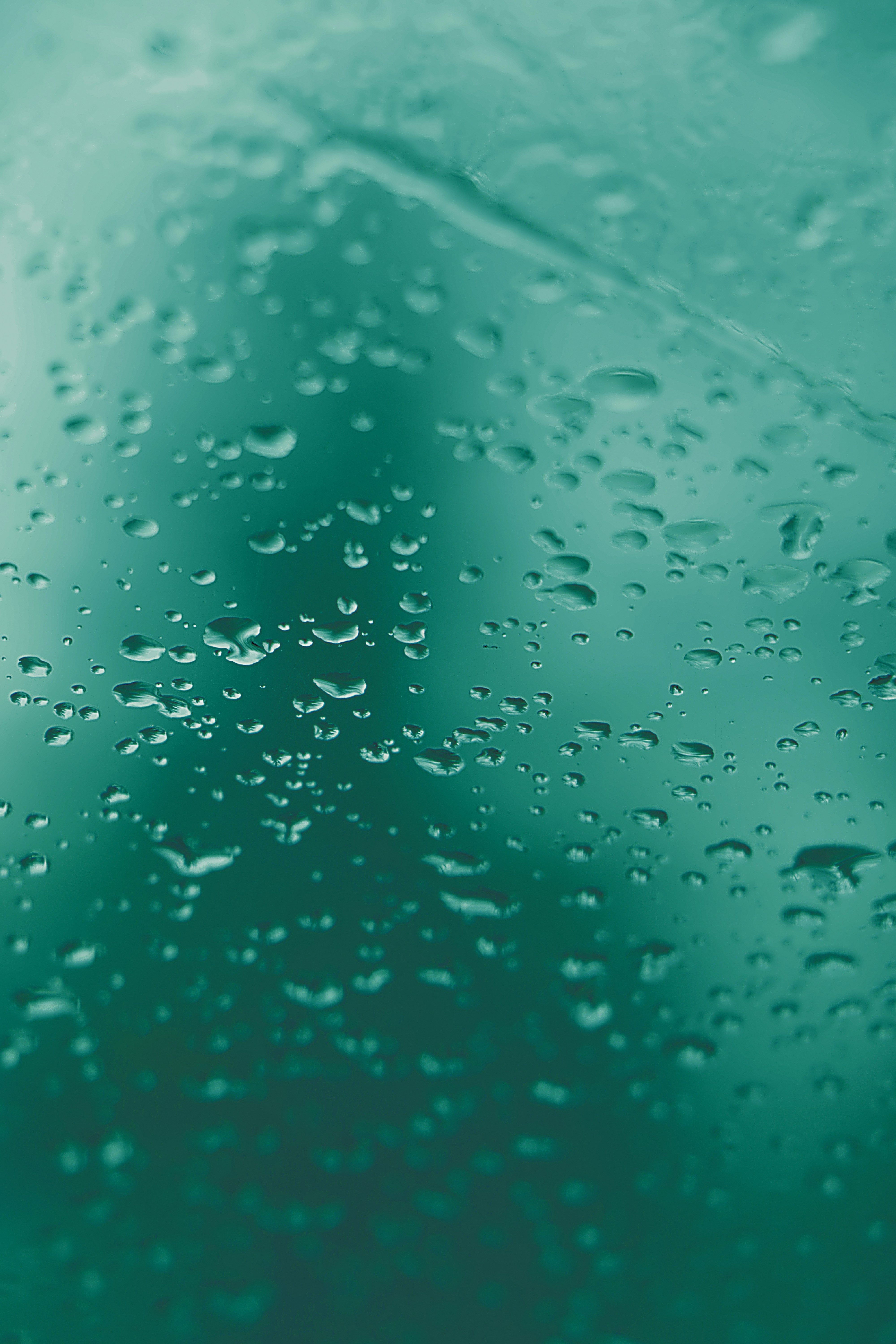 Drops in a Teal Quiet: A Micro-Lens Study of Rain on Glass
