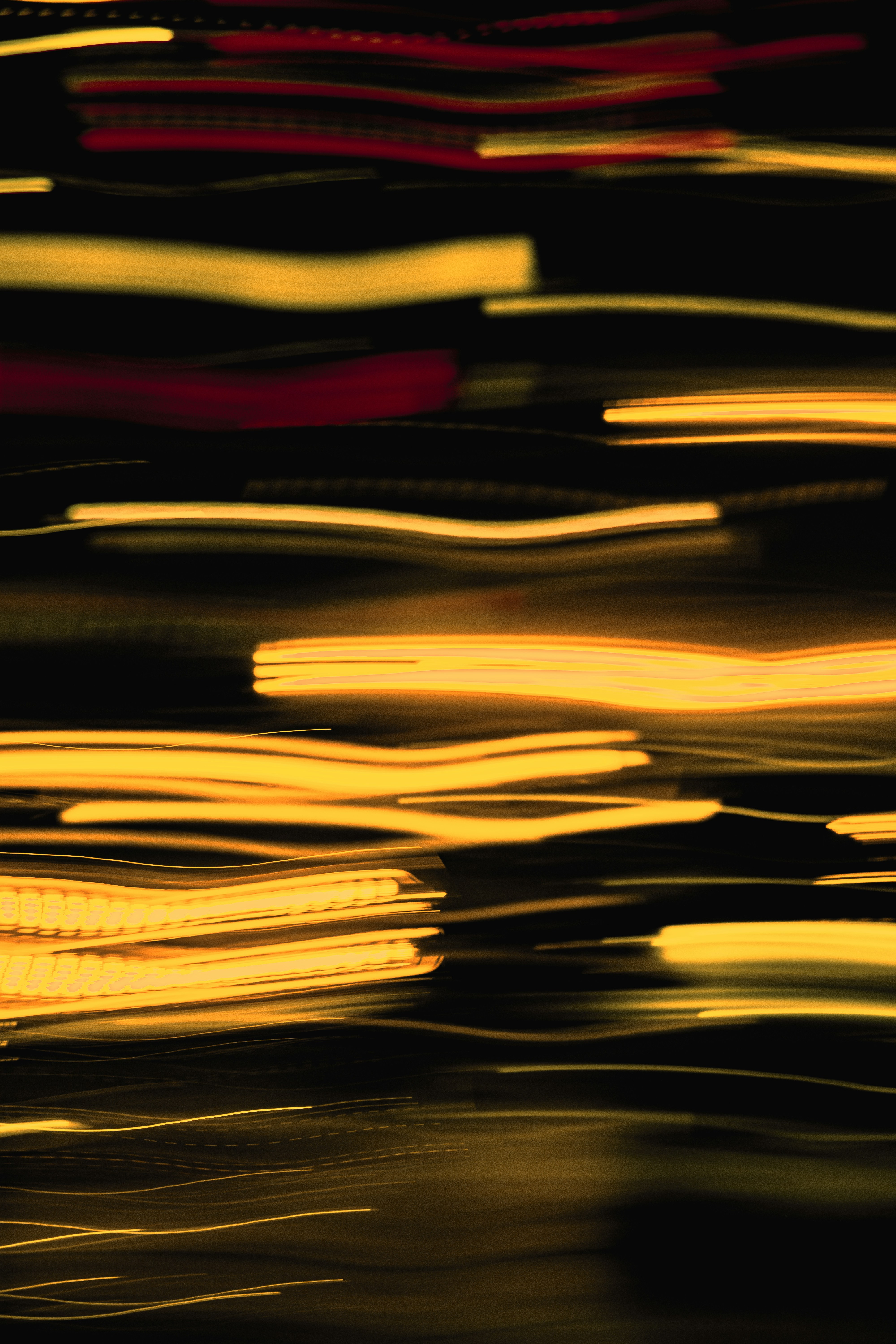 Wavy Golden Night: Bokeh Trails Across a Dark City