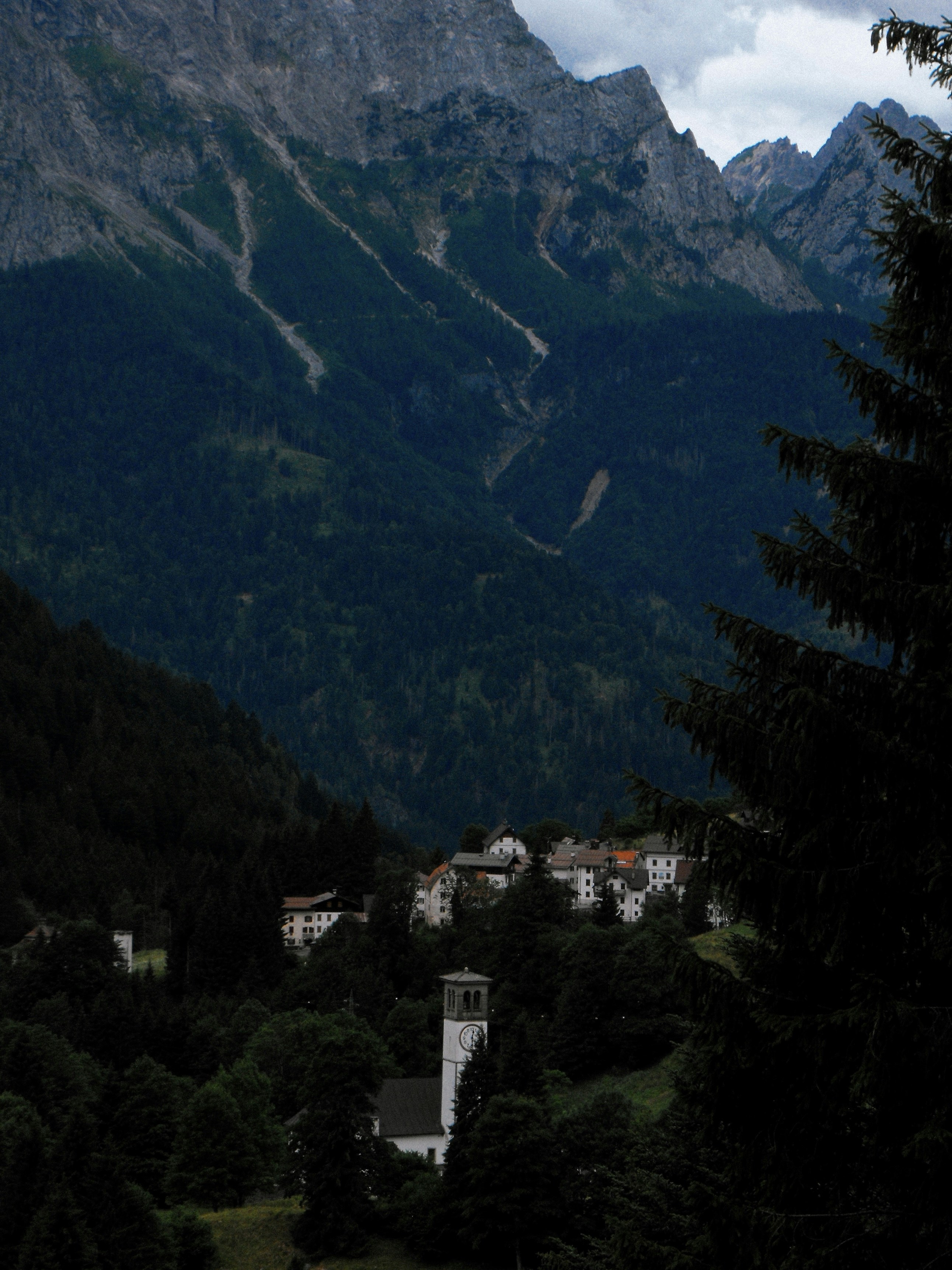 Village Embrace Beneath Towering Peaks