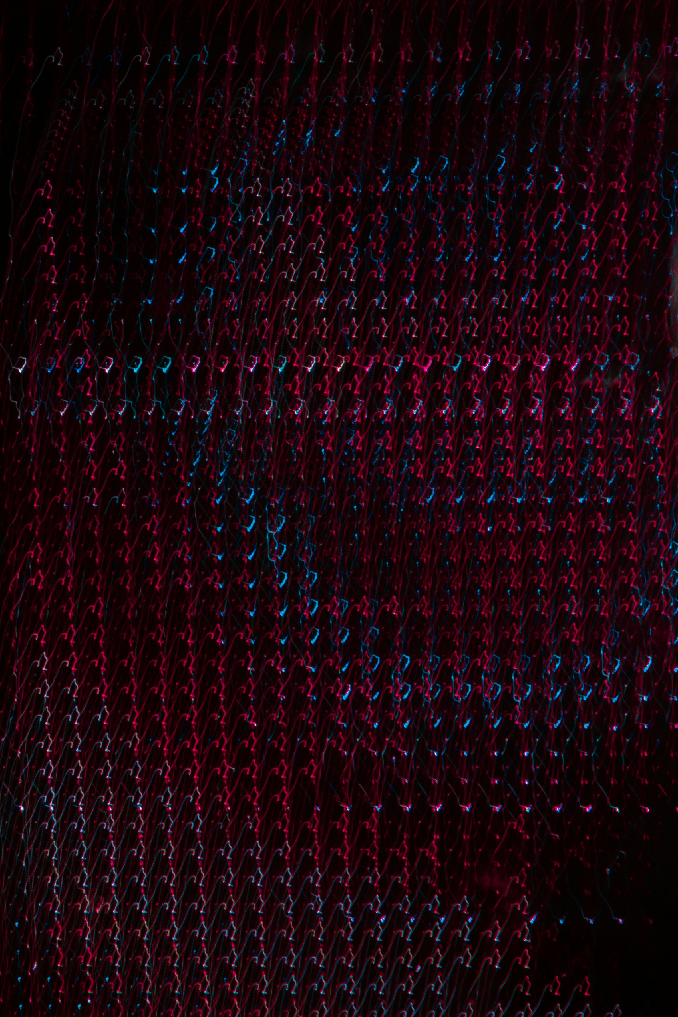 Veiled Neon Threads: A Night Scene of Moving Light Streaks