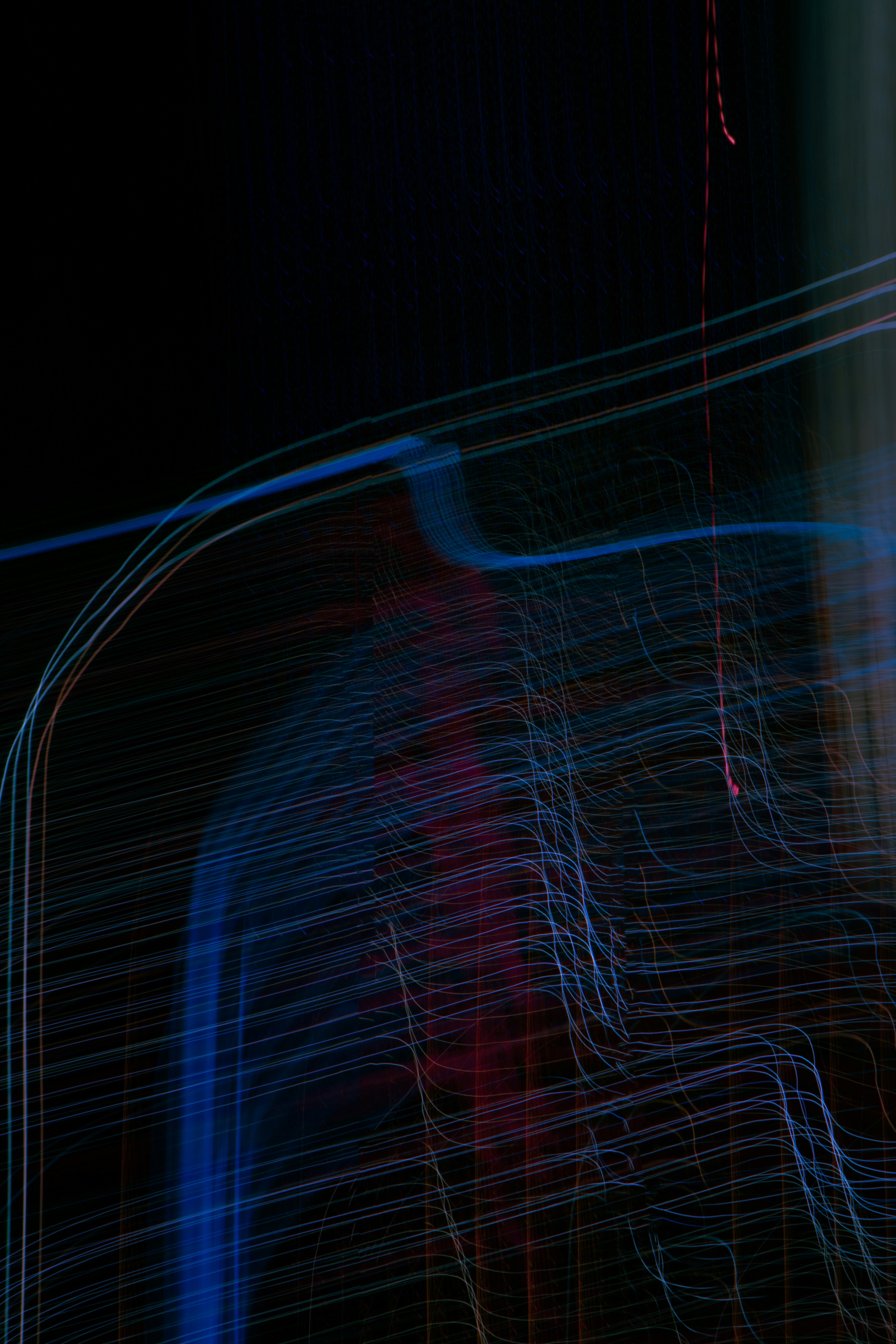 Neon Light Trails Over a Dim Cityscape