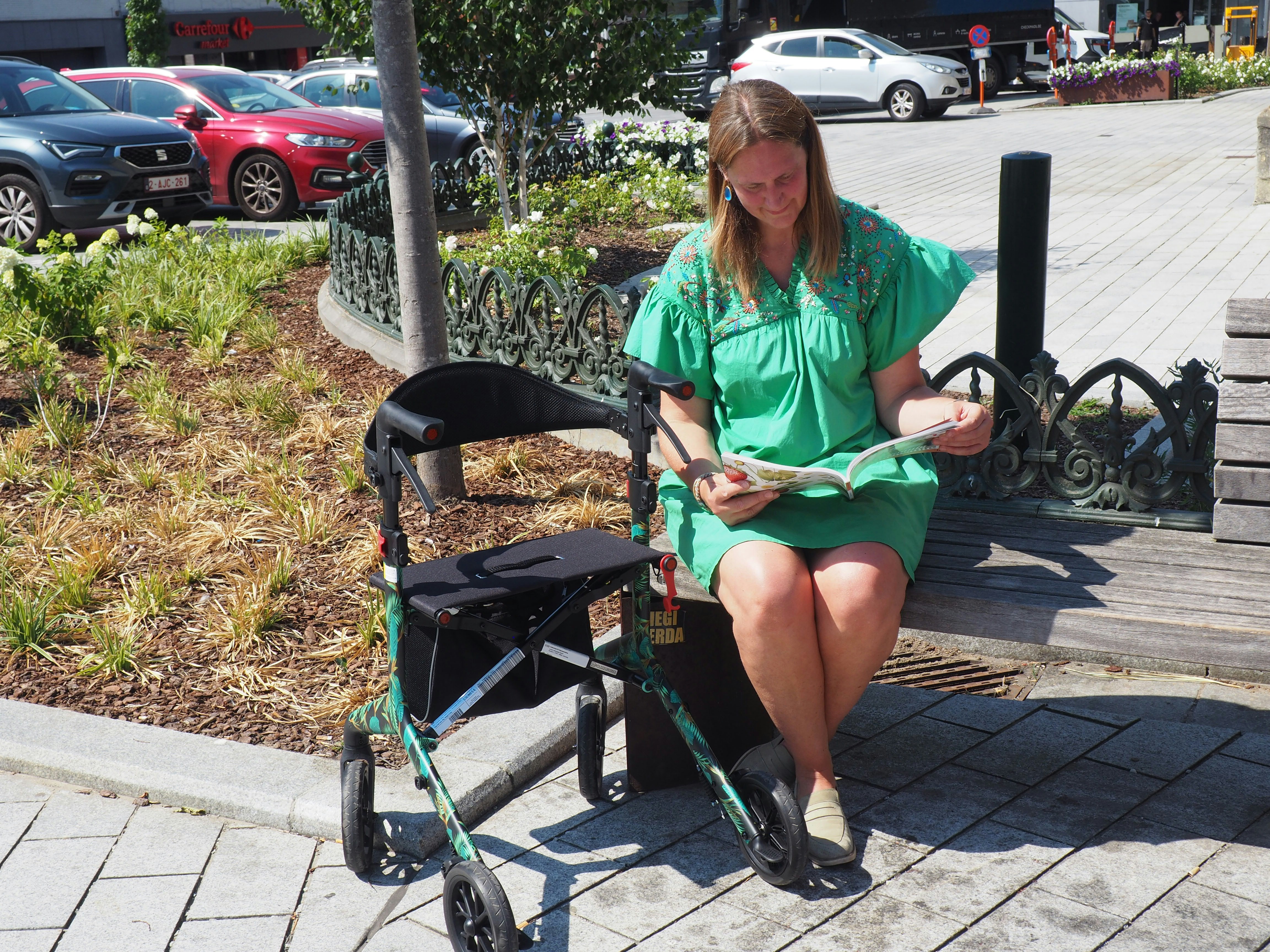 Portrait of a Reading Moment: A Woman in Green with a Baby-Stroller Walkway