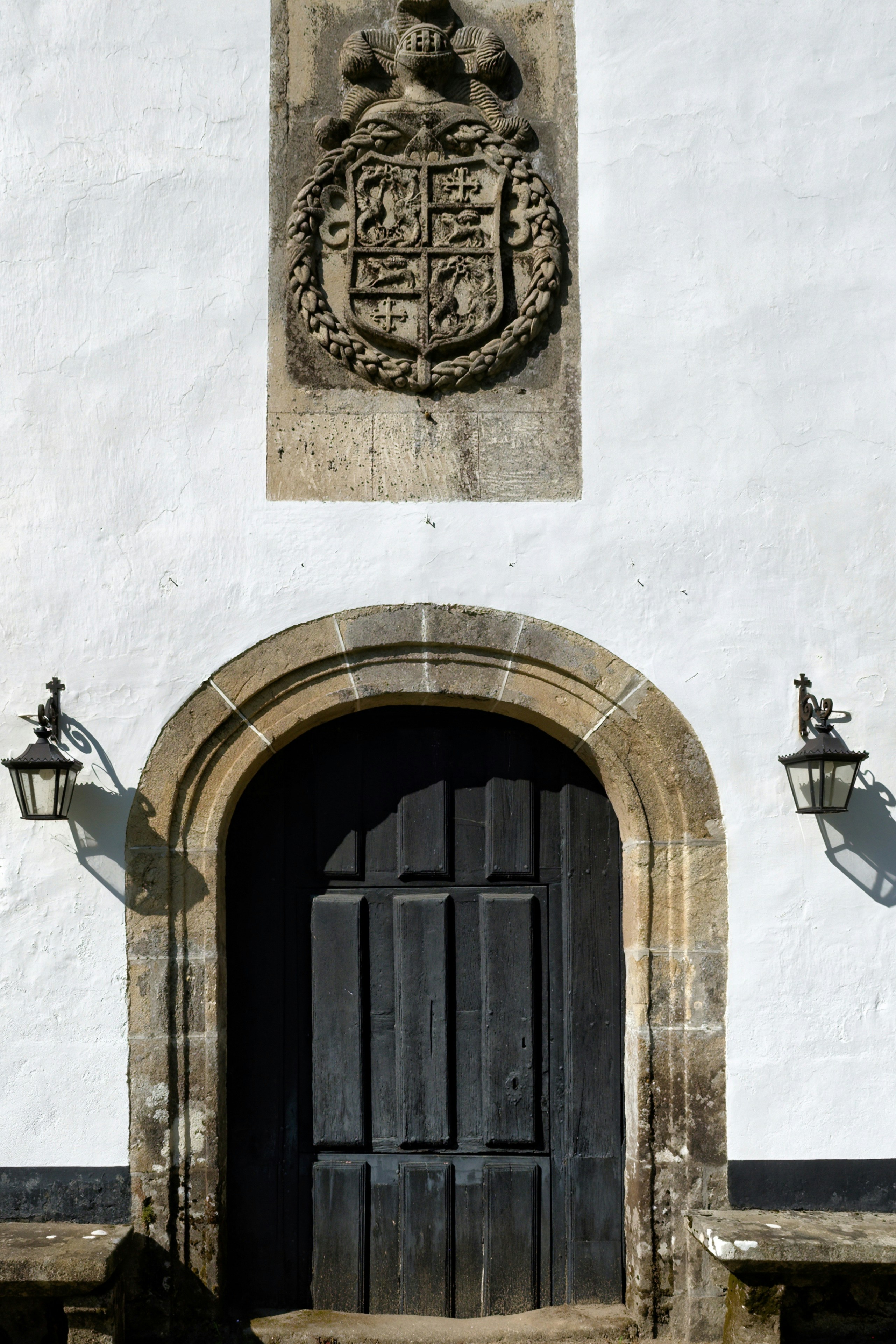 Heraldic Archway: A Quiet Door Beneath a Stone Crest