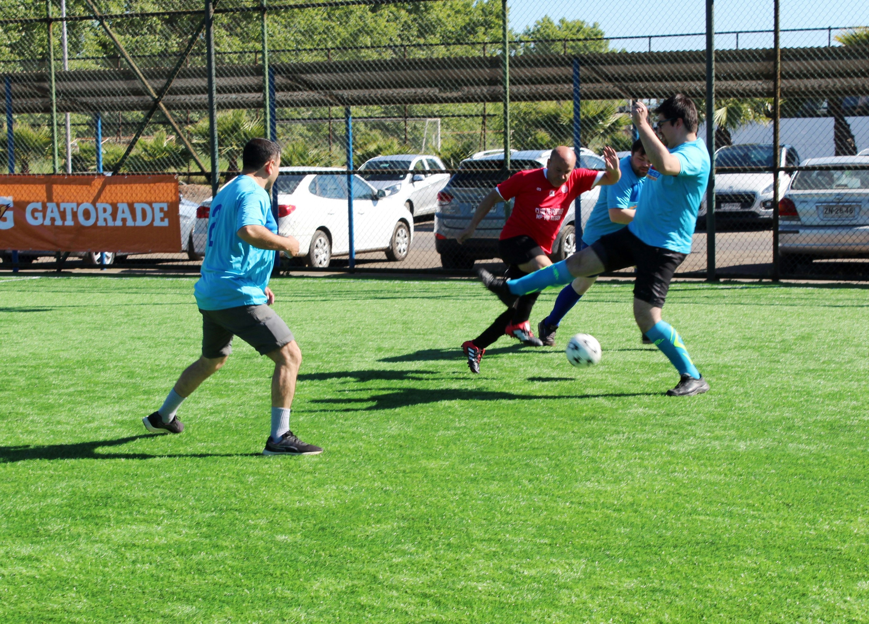 Midfield Clash: A Defender Full-Stride Challenge for the Ball
