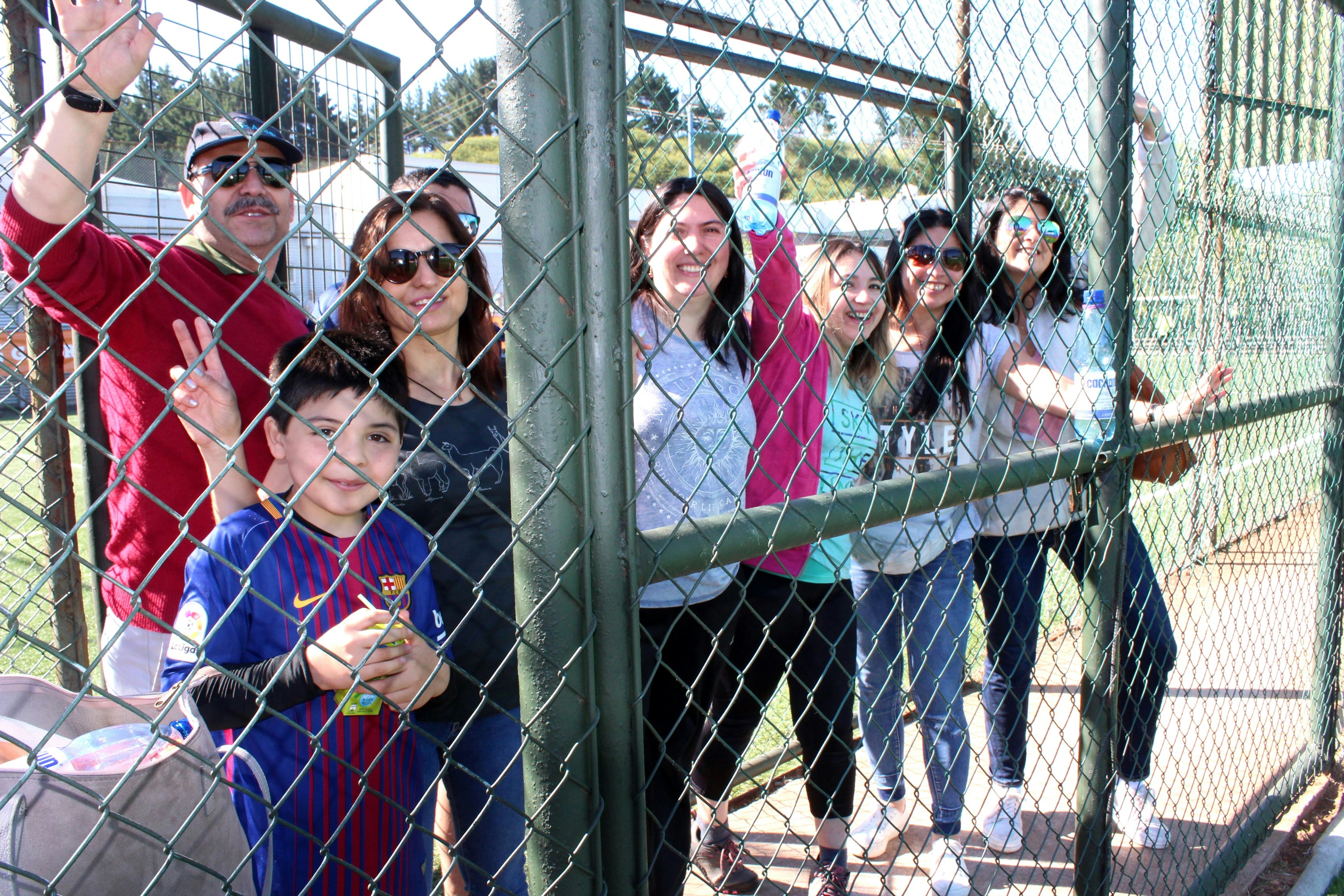 Chain-link Cheer: A Rowdy Group Hangs Tight at the Field Fence