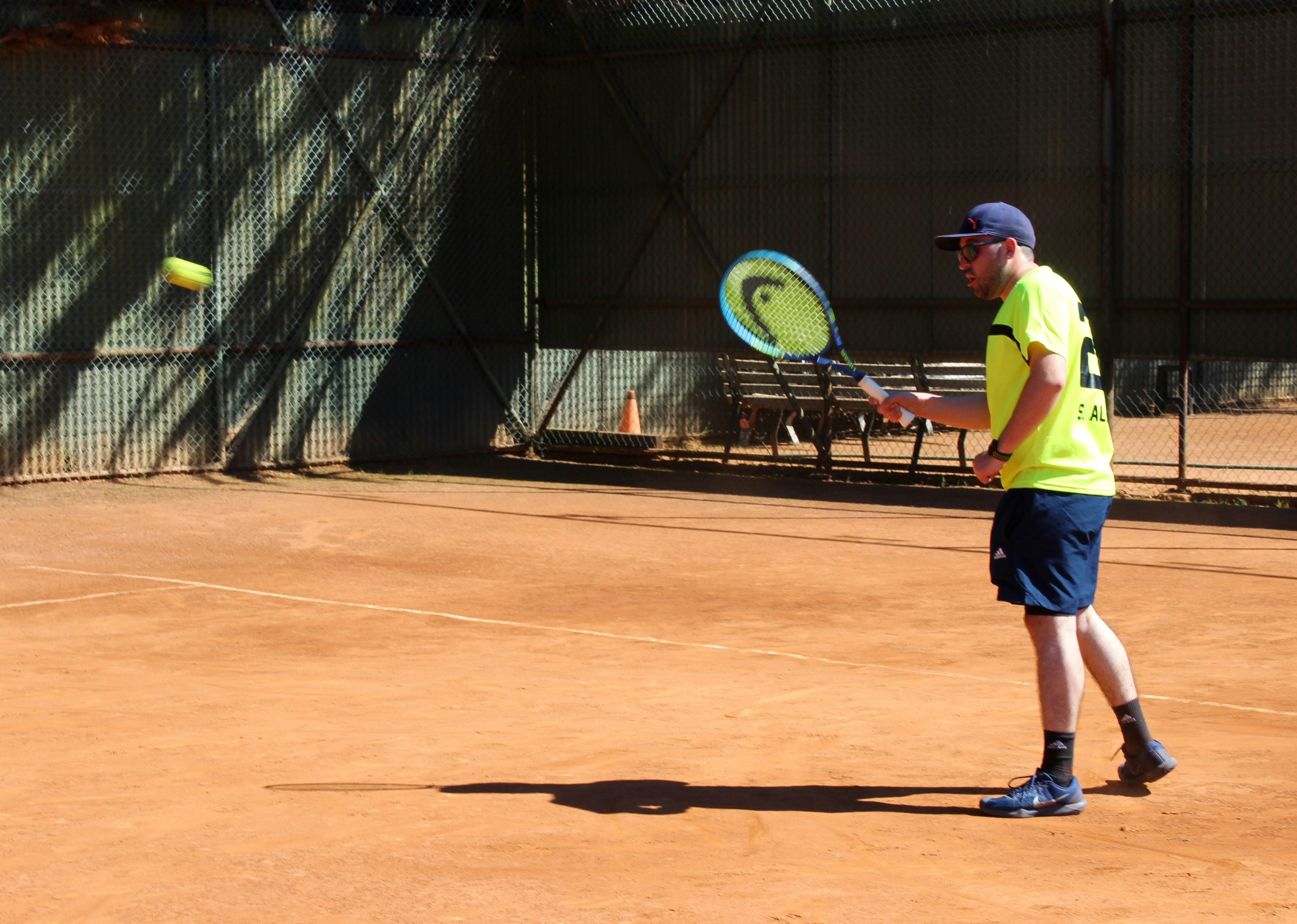 Lone Tennis Player Preparing a Forehand on a Clay Court
