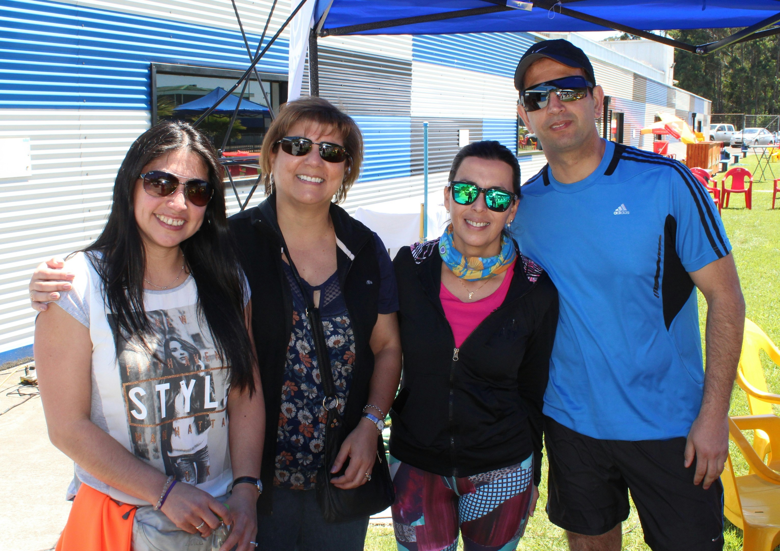 Sunlit Quartet: Friends Under a Blue Canopy