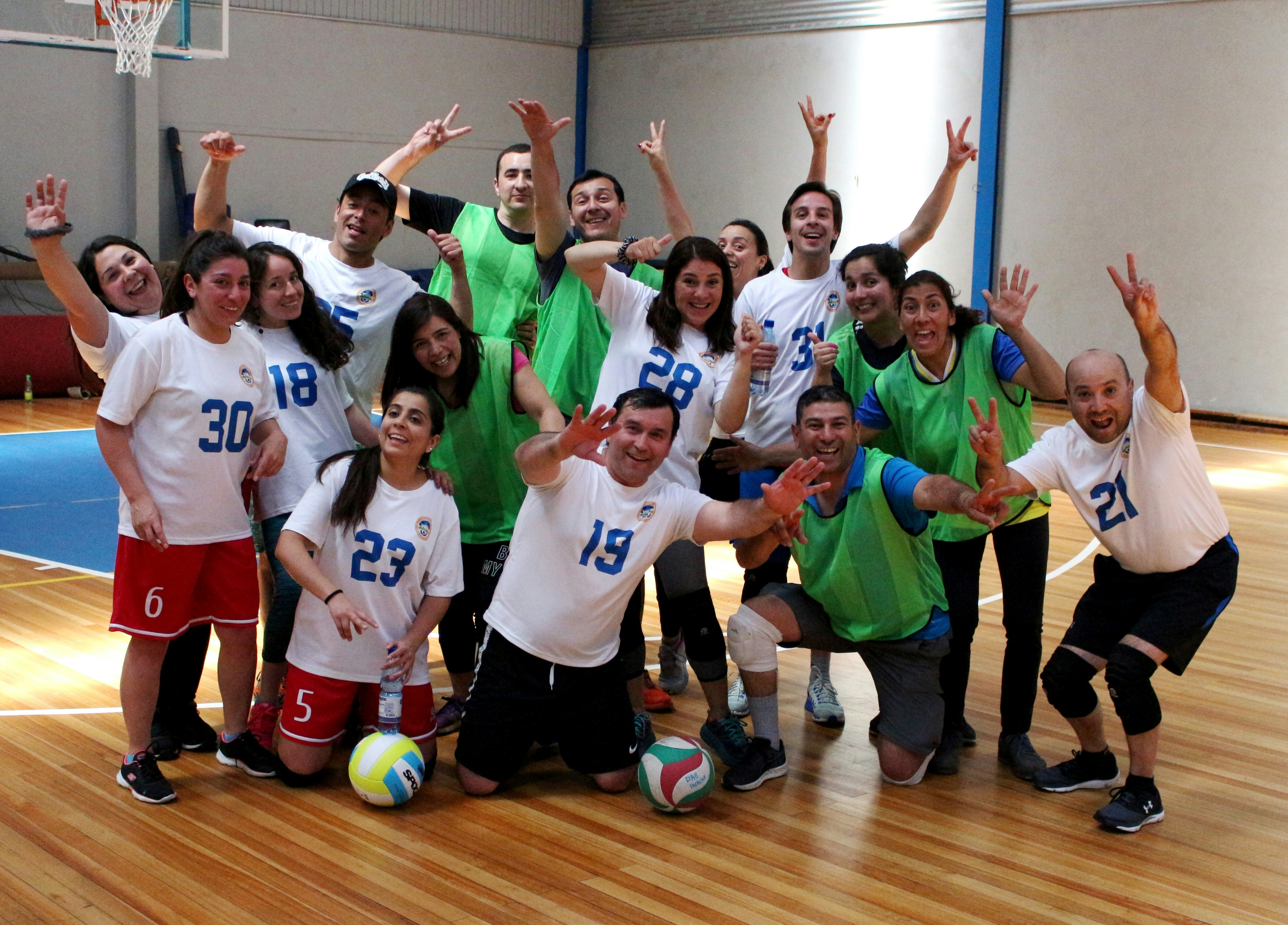 Team Victory: A Colorful Indoor Soccer Volley Upbeat Group Shot