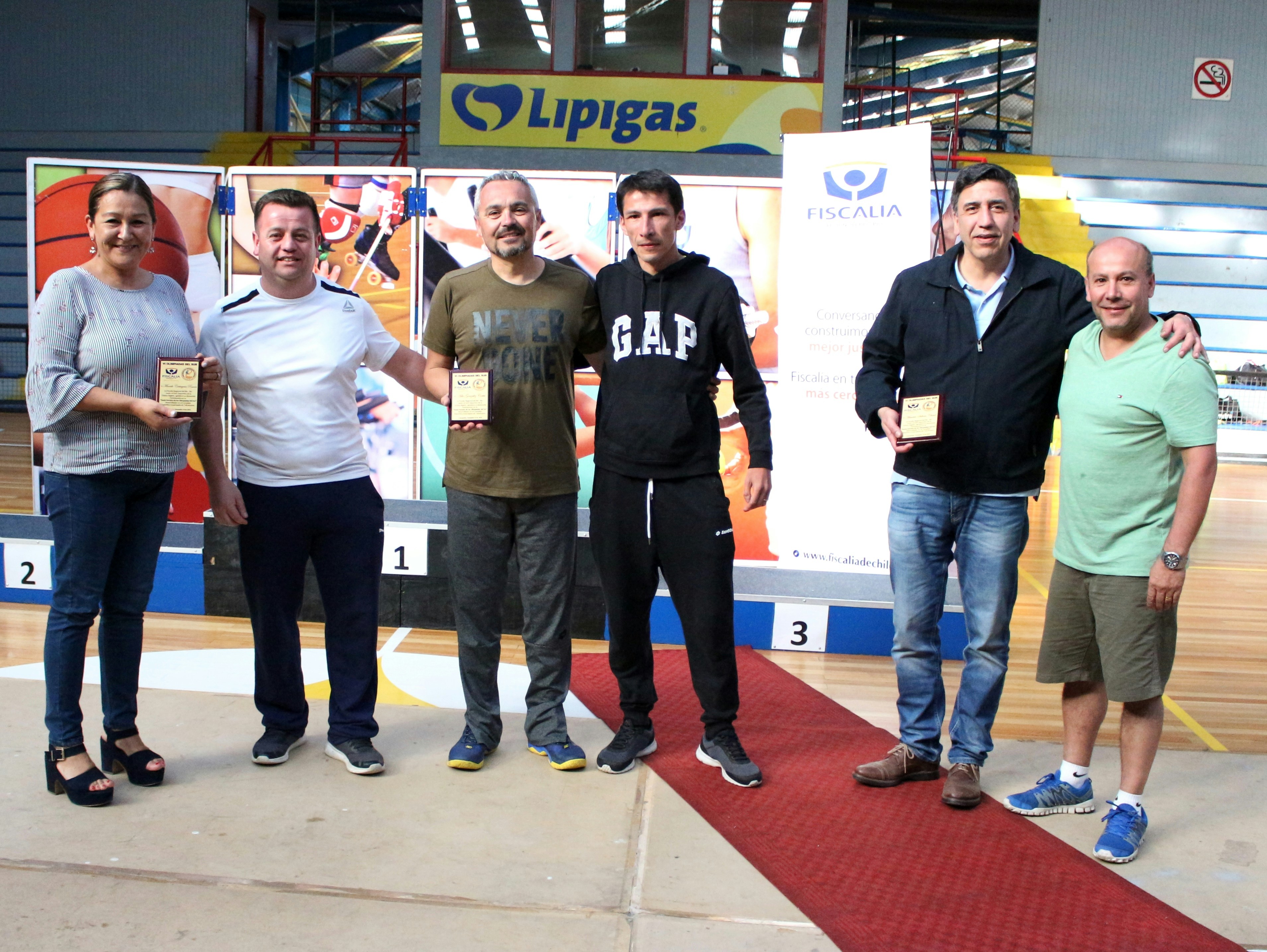 Award Ceremony at a Sports Venue: Group of Men with Medals and Plaques