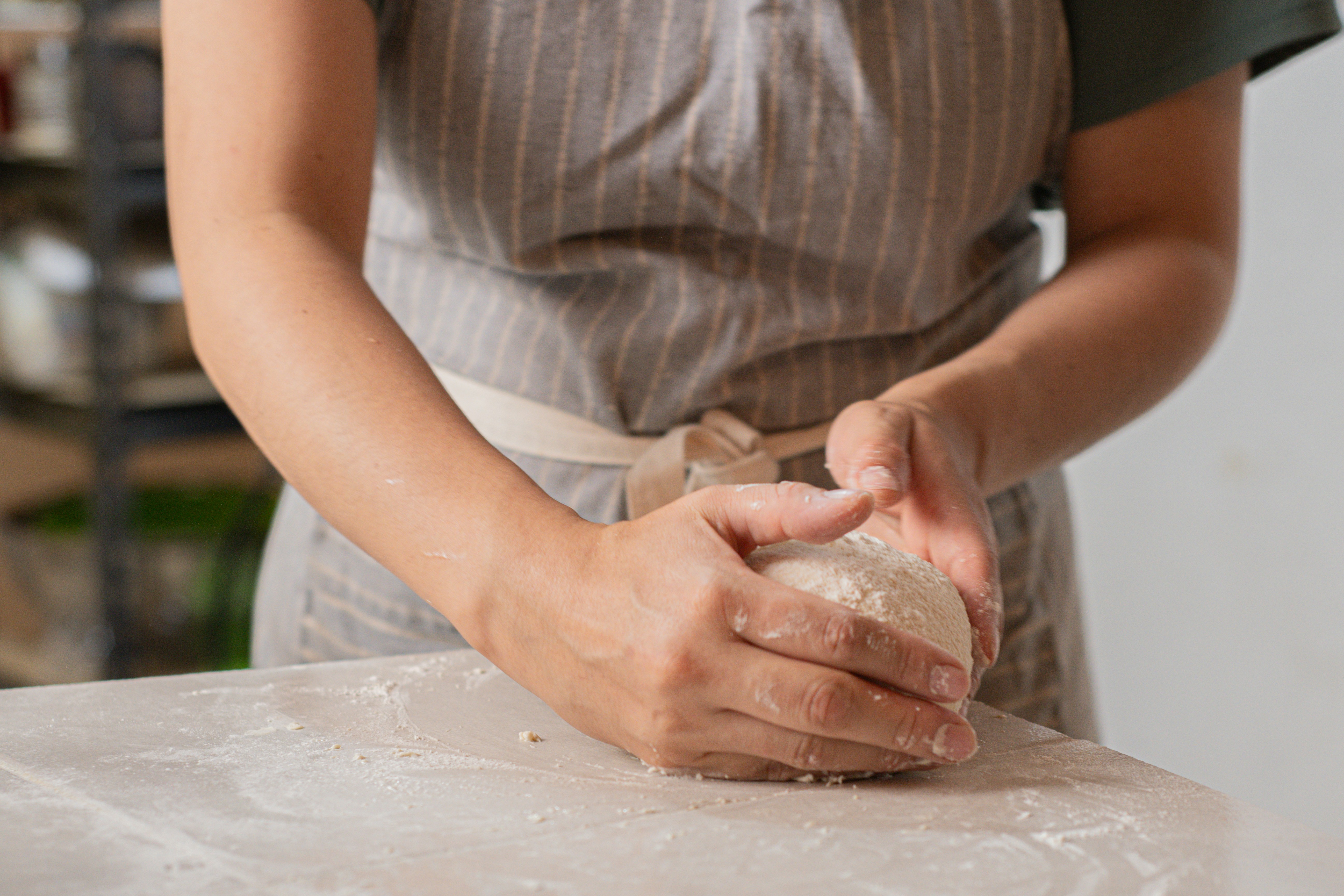 Hands at Work: kneading dough on a floured wooden surface