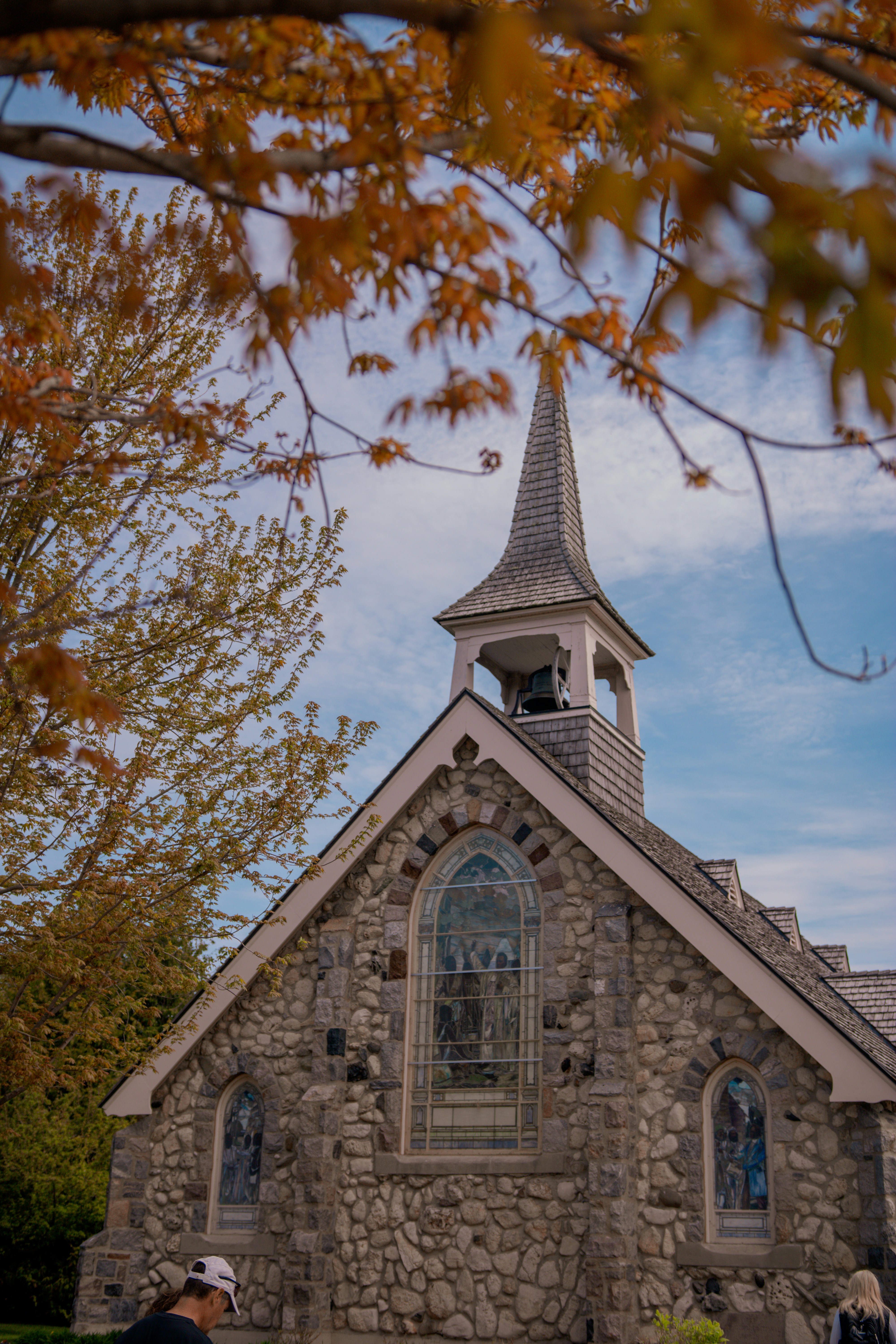 Stone Church Tower Framed by Autumn Canopy