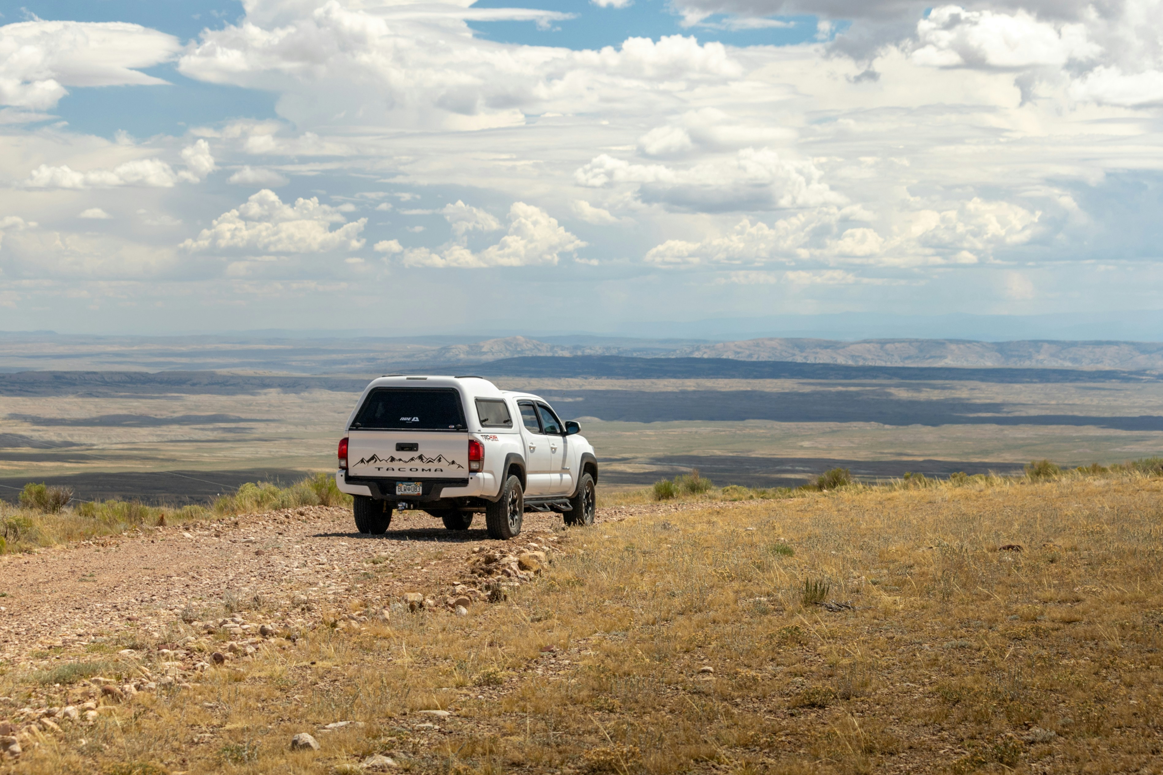 Dusty Plateau Escape: The Pickup Clings to the Horizon