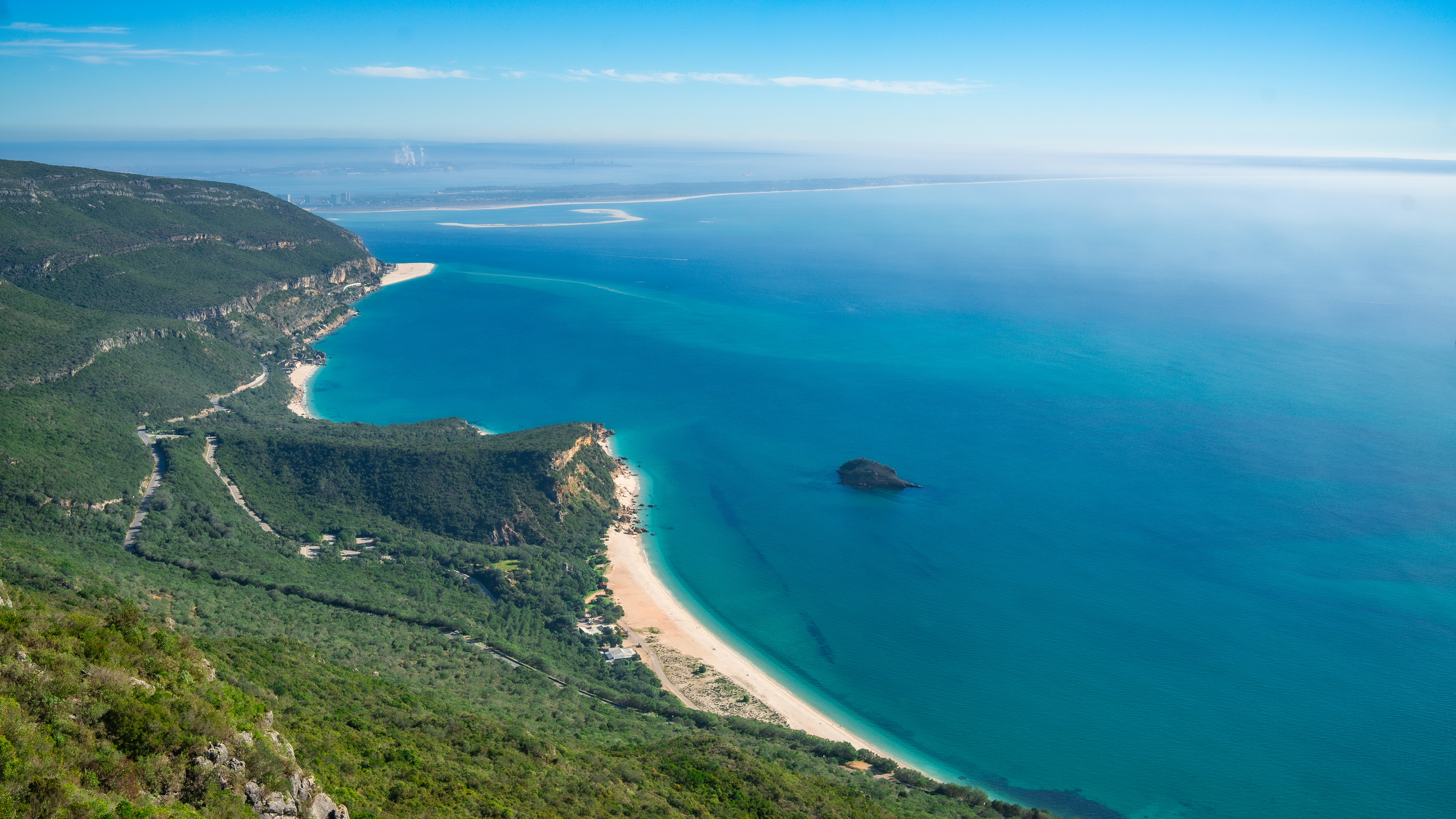 Coastal Curve: Aerial View of Verdant Cliffs and Turquoise Shore