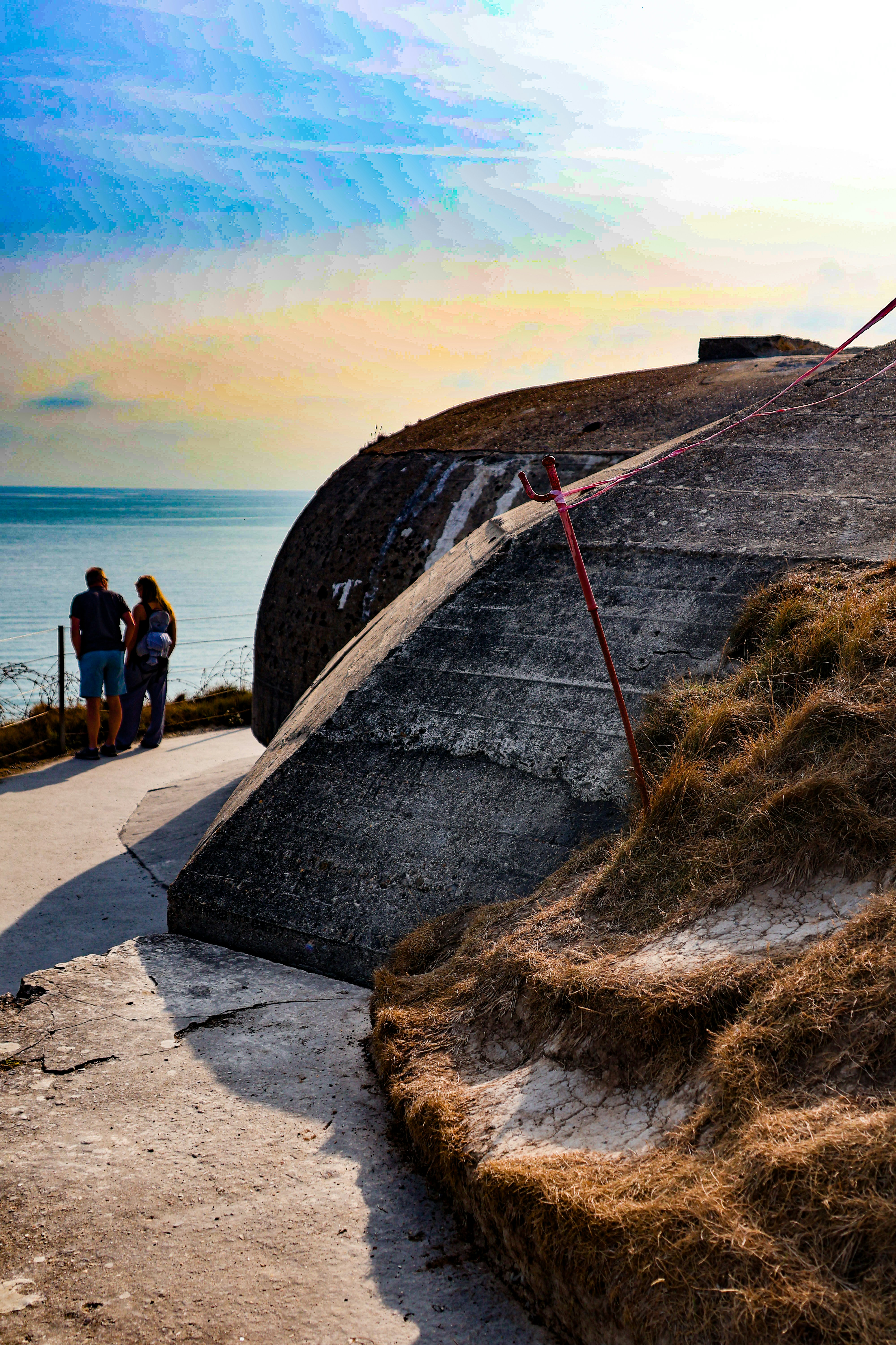 People at the edge: coastal structure and sea horizon at golden hour