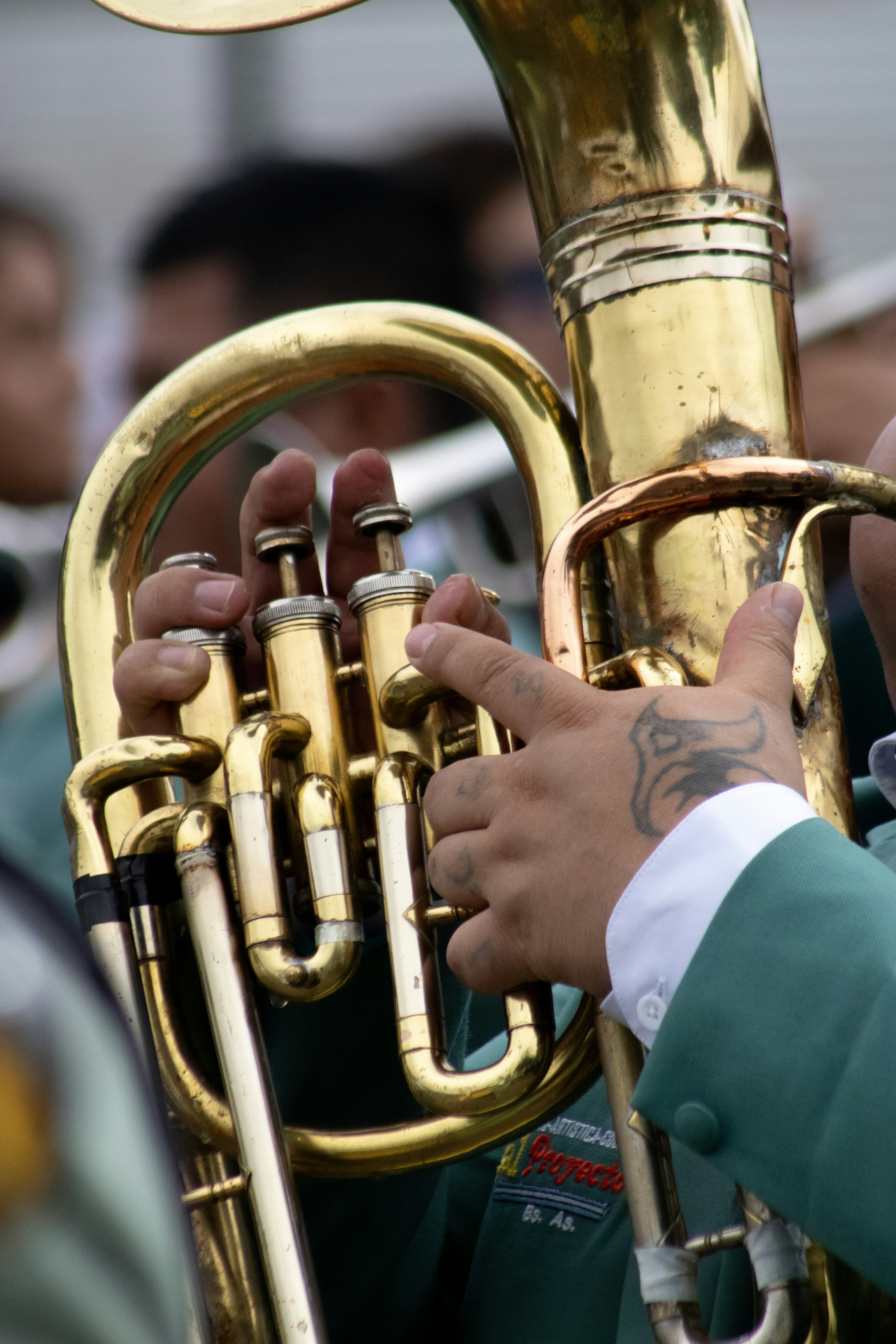 Brass Melodies: Hands Guiding a Brass Instrument