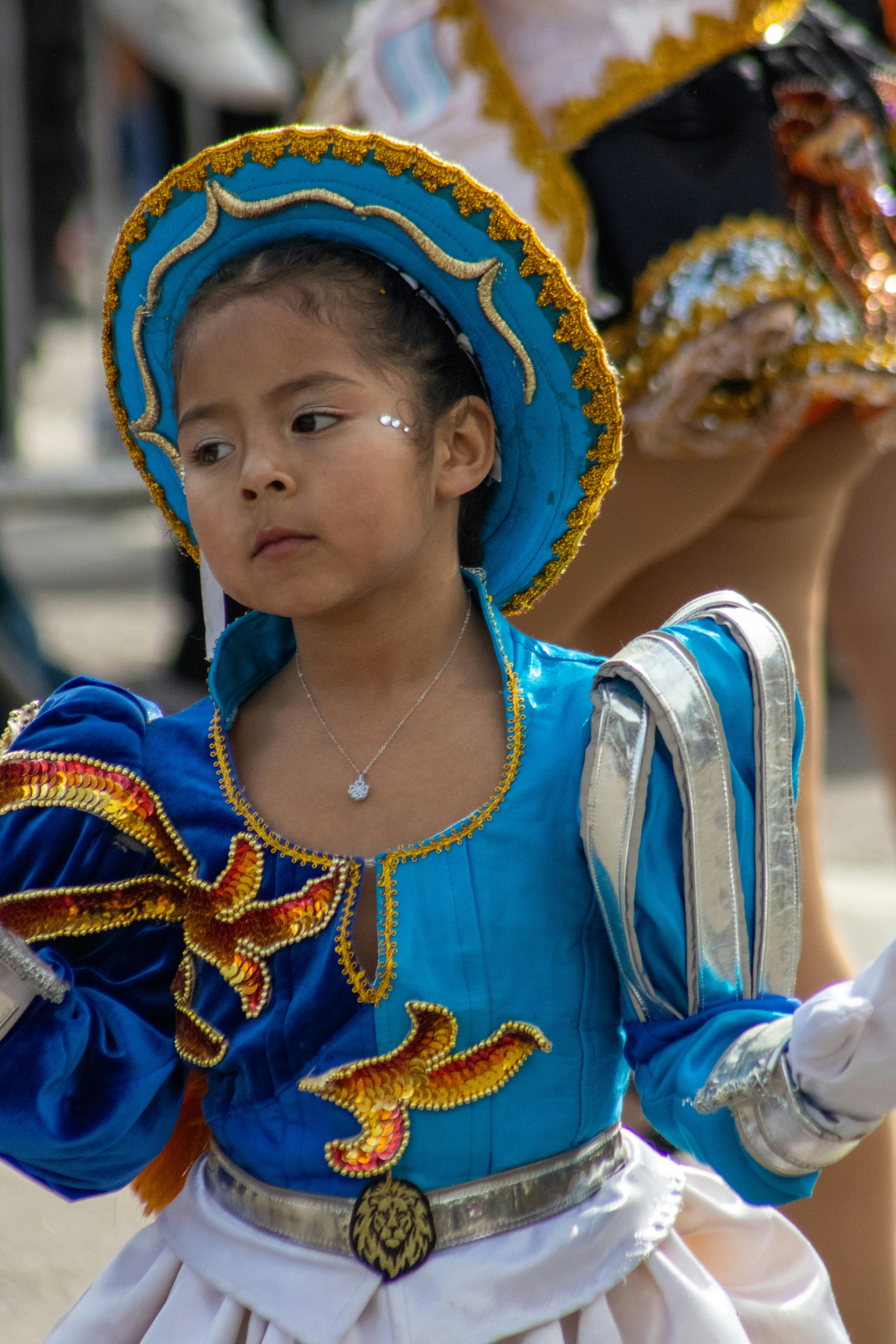 Blue Carnival Dress: A Young Dancer in a Sparkling Parade