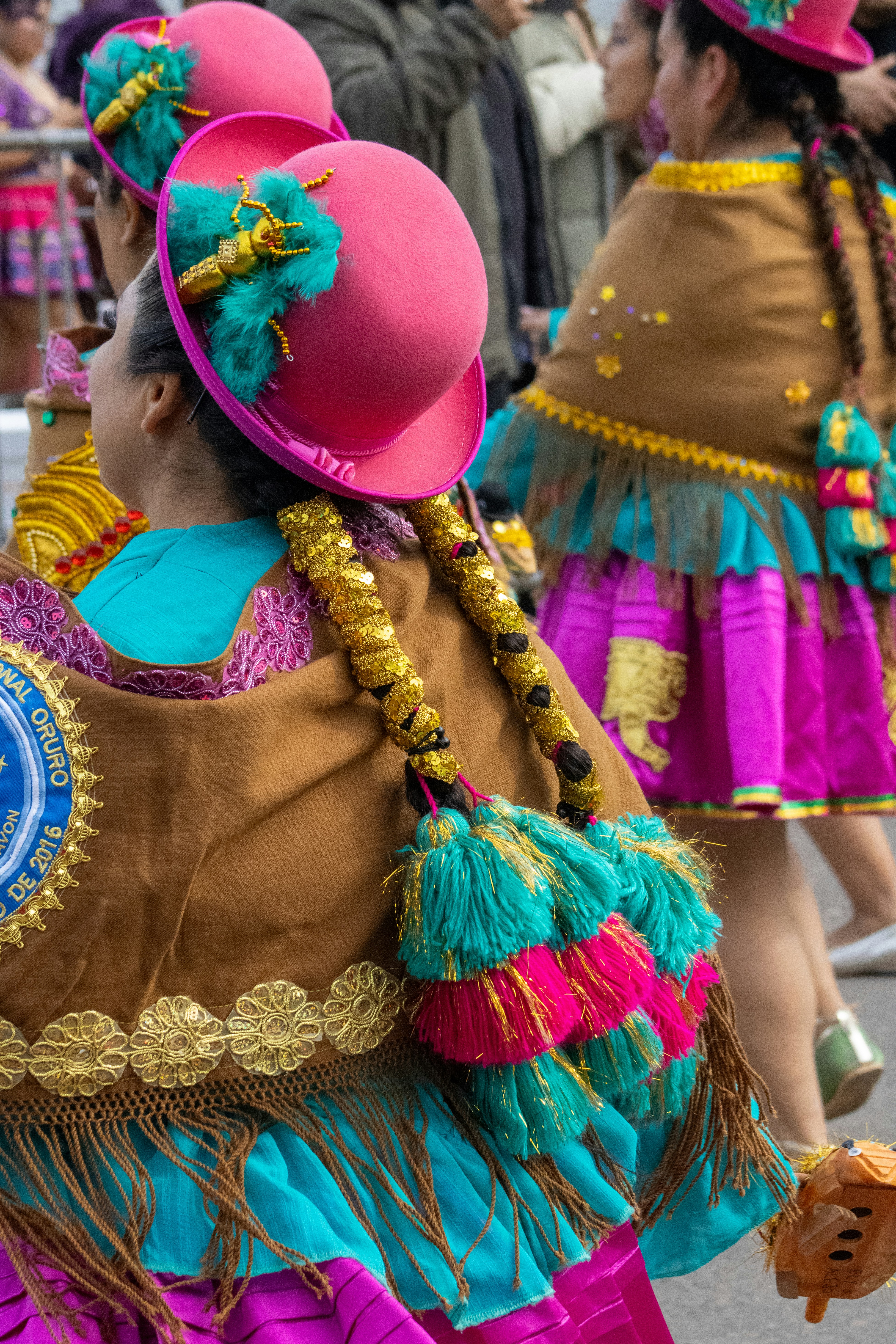 Fiesta in Fuchsia: Traditional Attire and Colorful Tassels at a Cultural Parade
