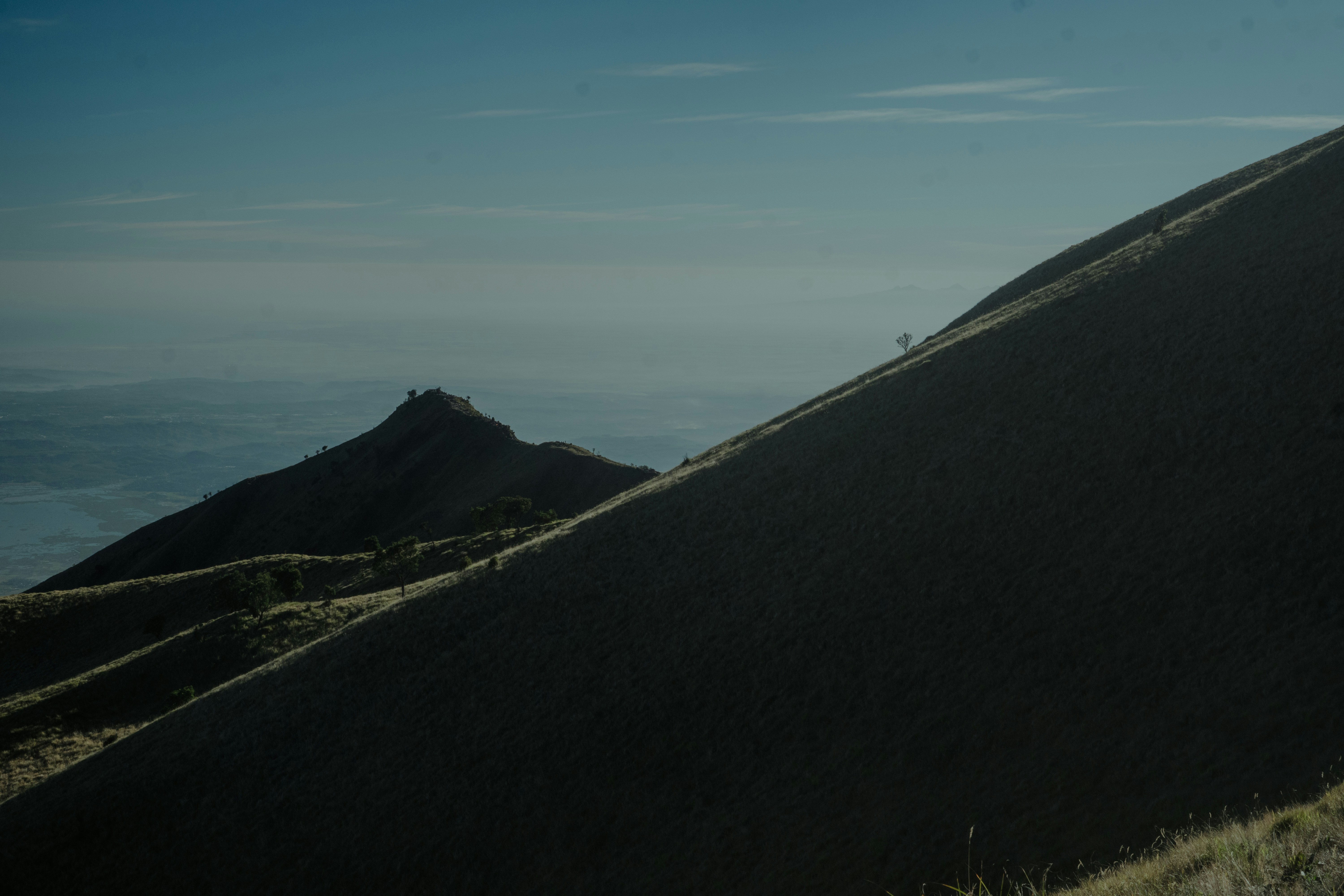 Slope of Silence: A Ridge Surged Between Shadows and Sky