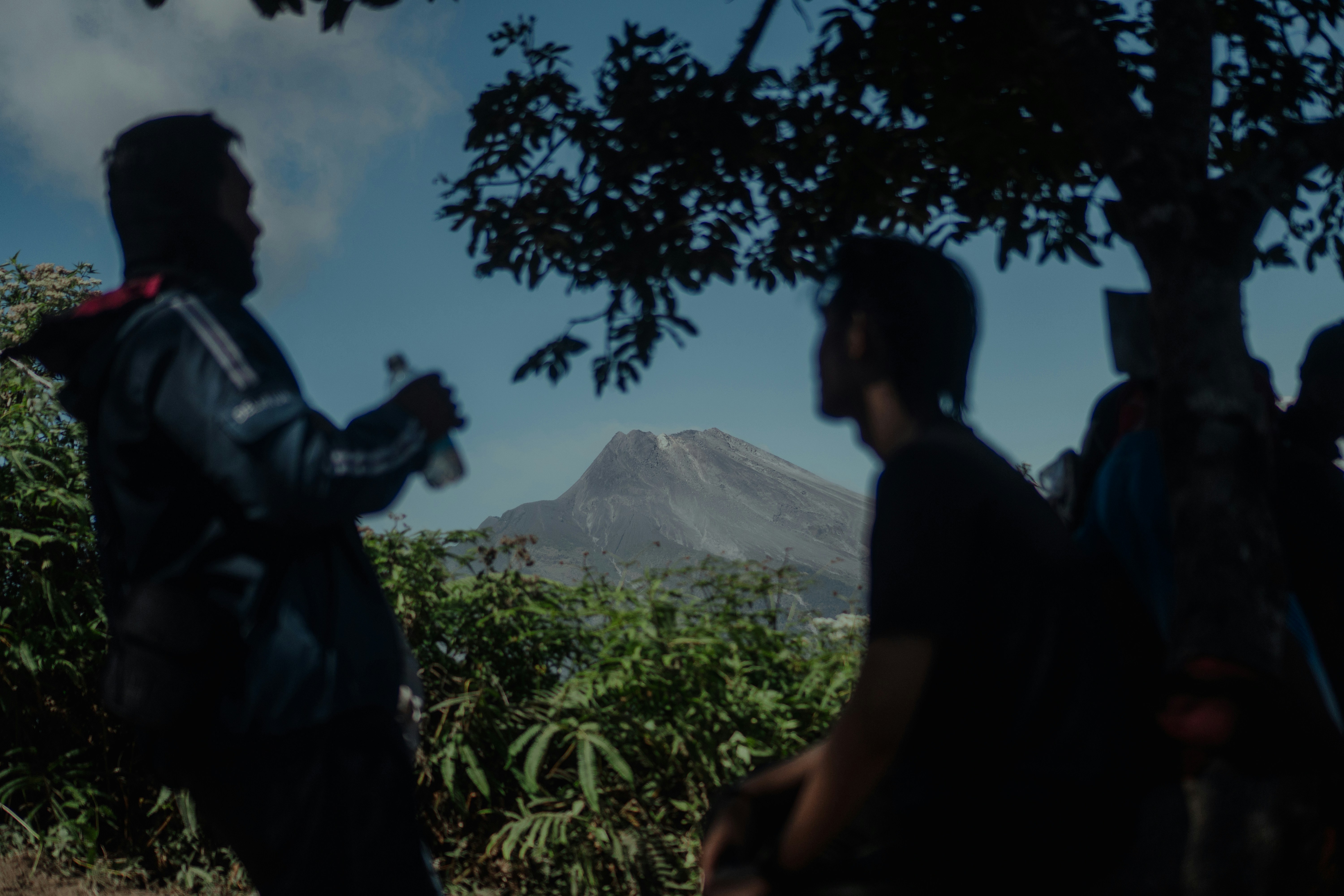 Volcanic Vista Between Silhouetted Travelers