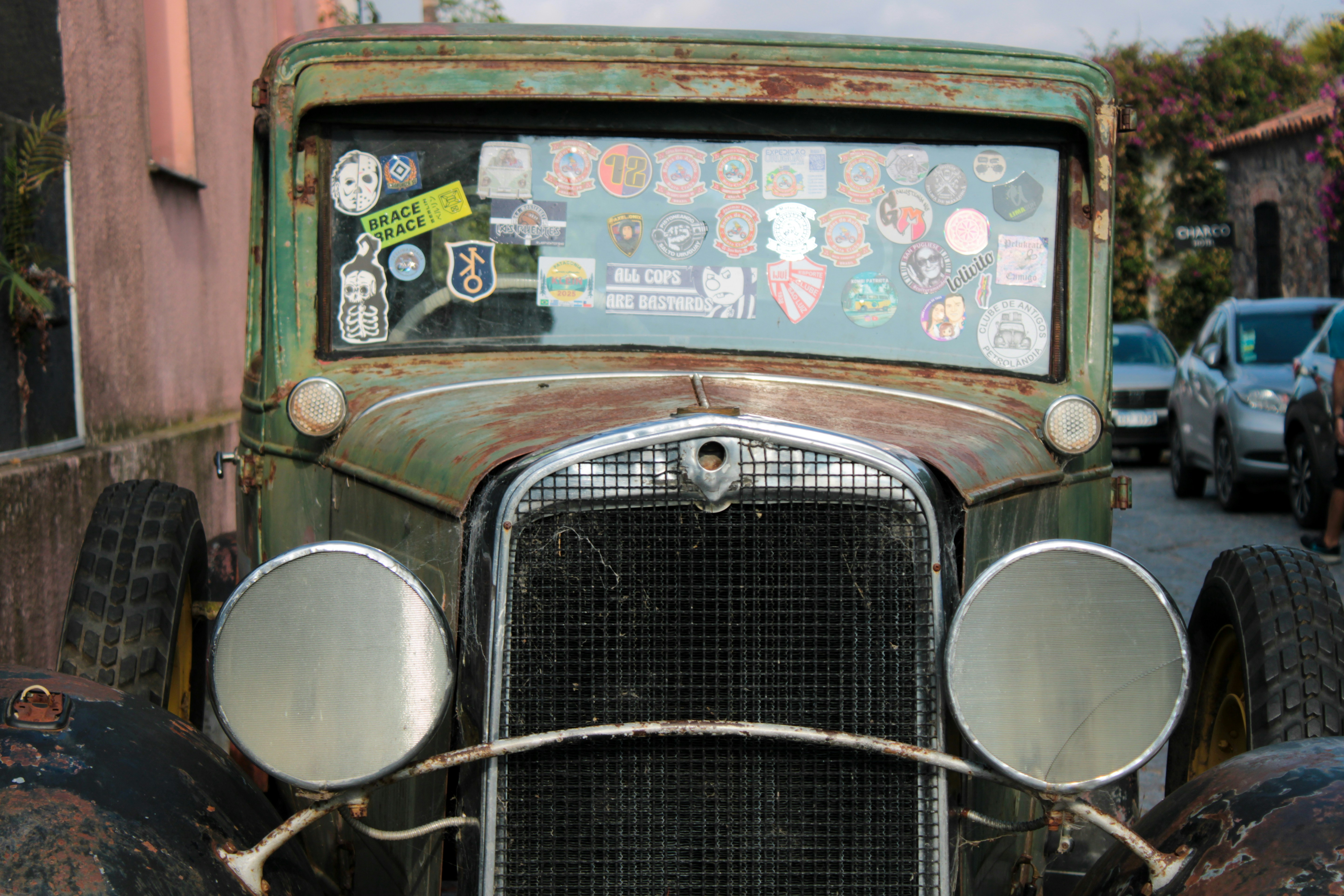 Rusty Sentinel: The Stickered Classic Watching Over the Street