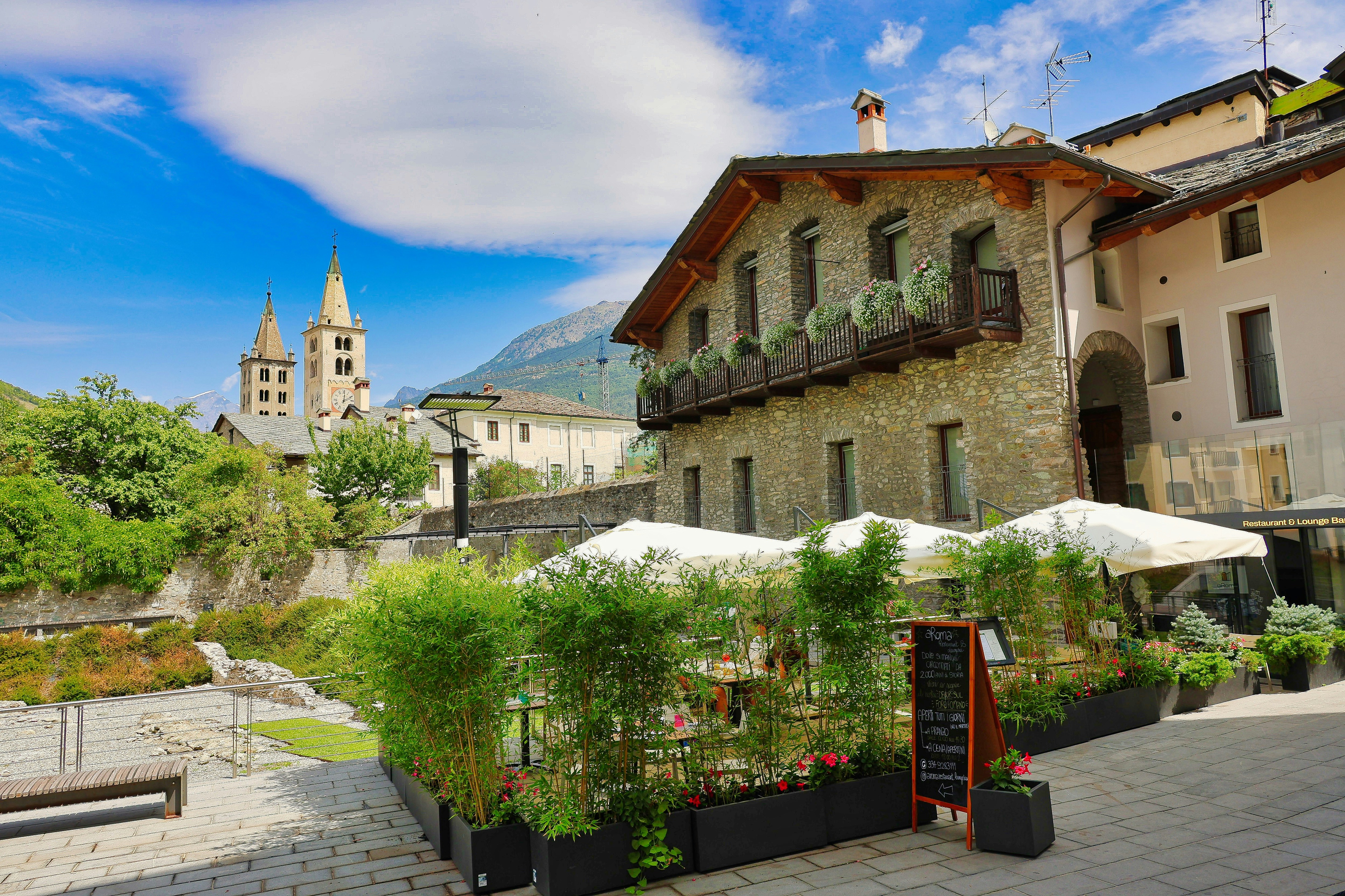 Cobbled Village Café at the Foot of Alpine Facades
