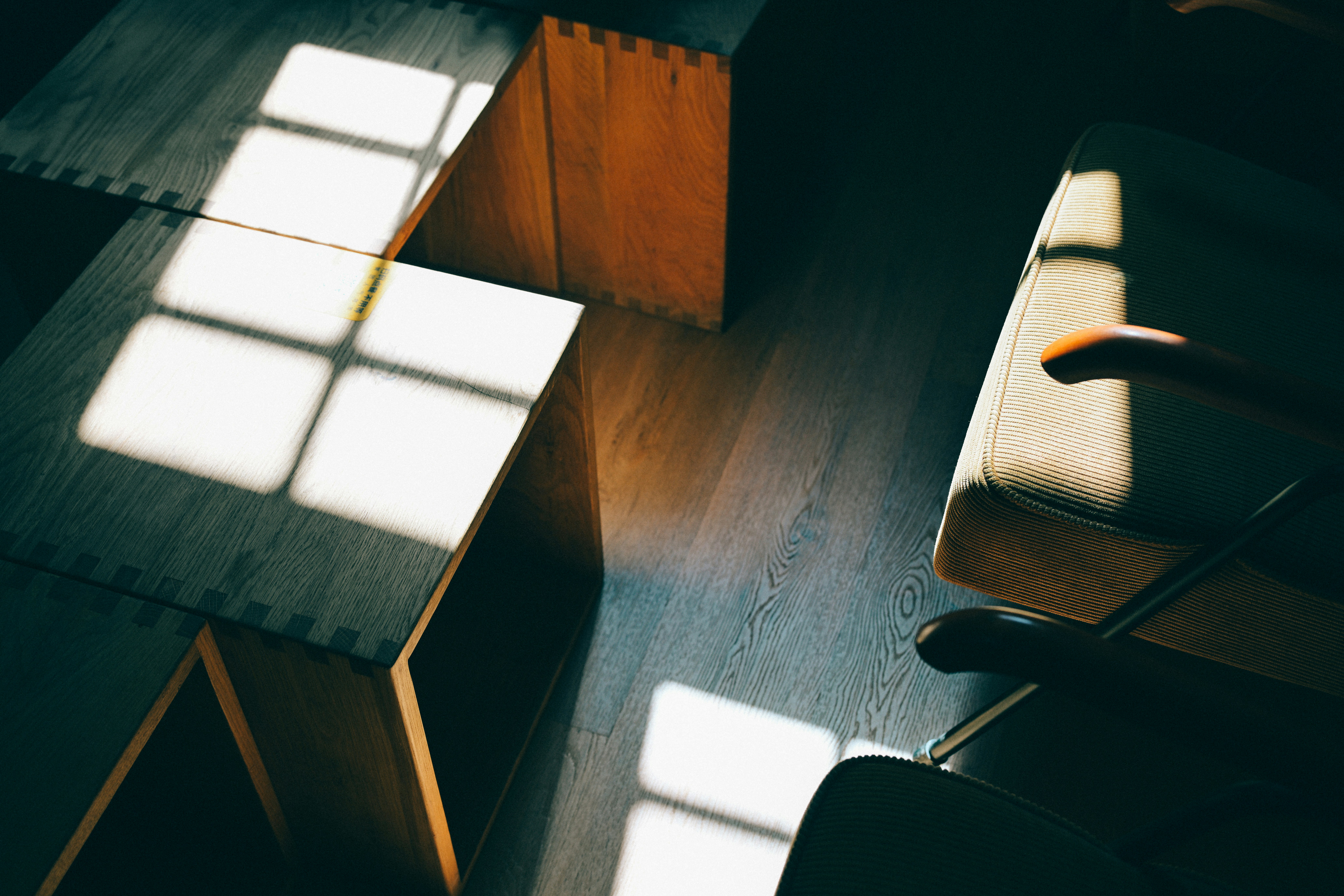 Sunlit Playroom: Geometric Blocks and Shadows on a Wooden Floor