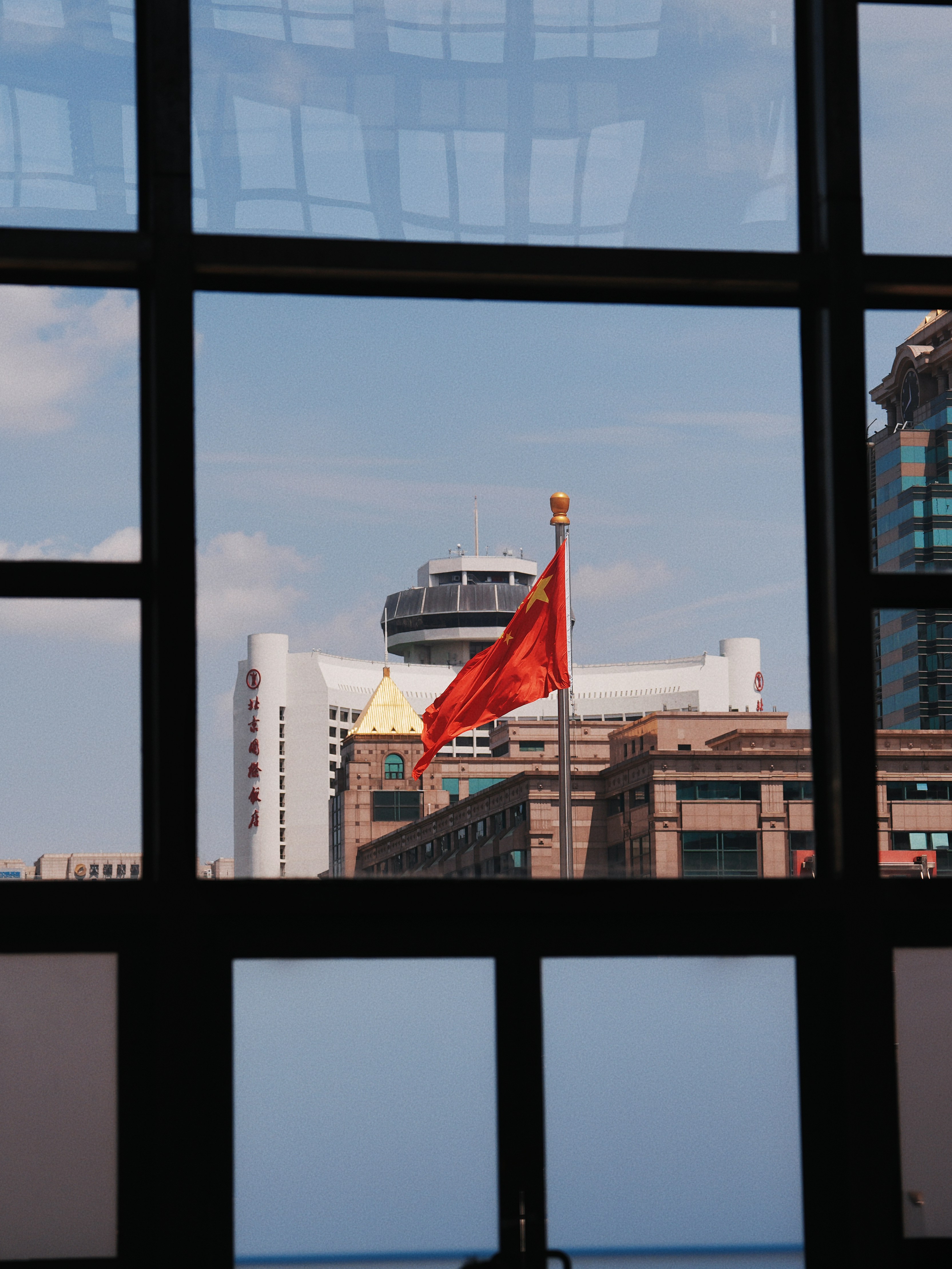 Red Flag Over Framed Skyscrapers