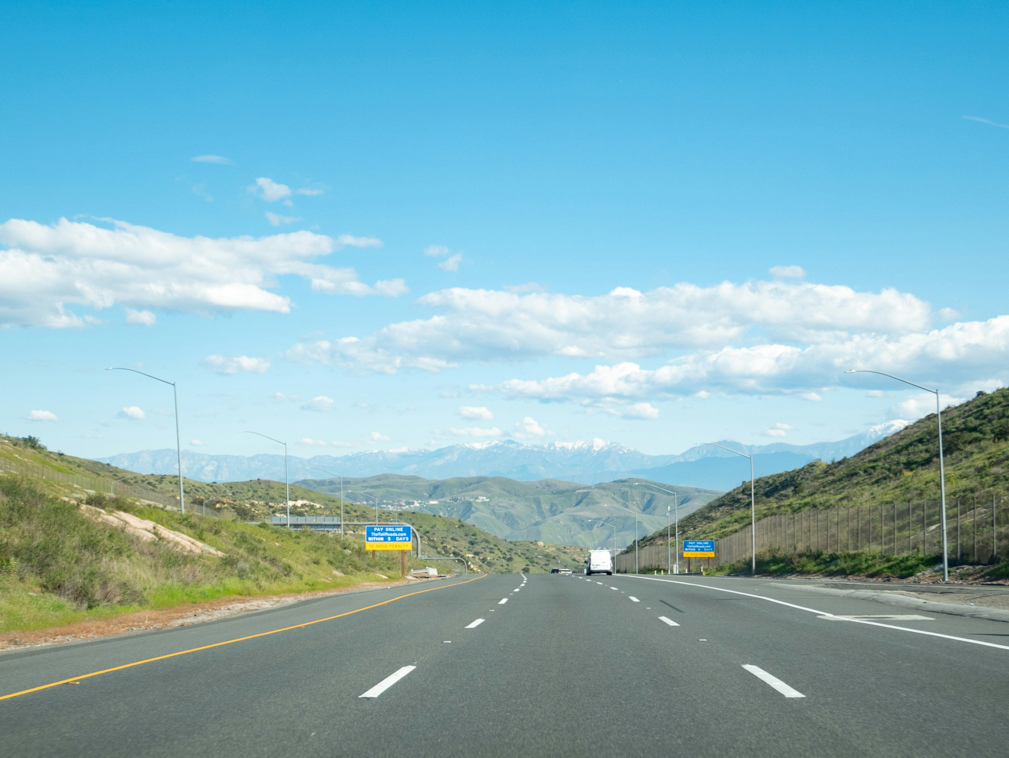 Vast Mountain Highway Under a Bright Blue Sky
