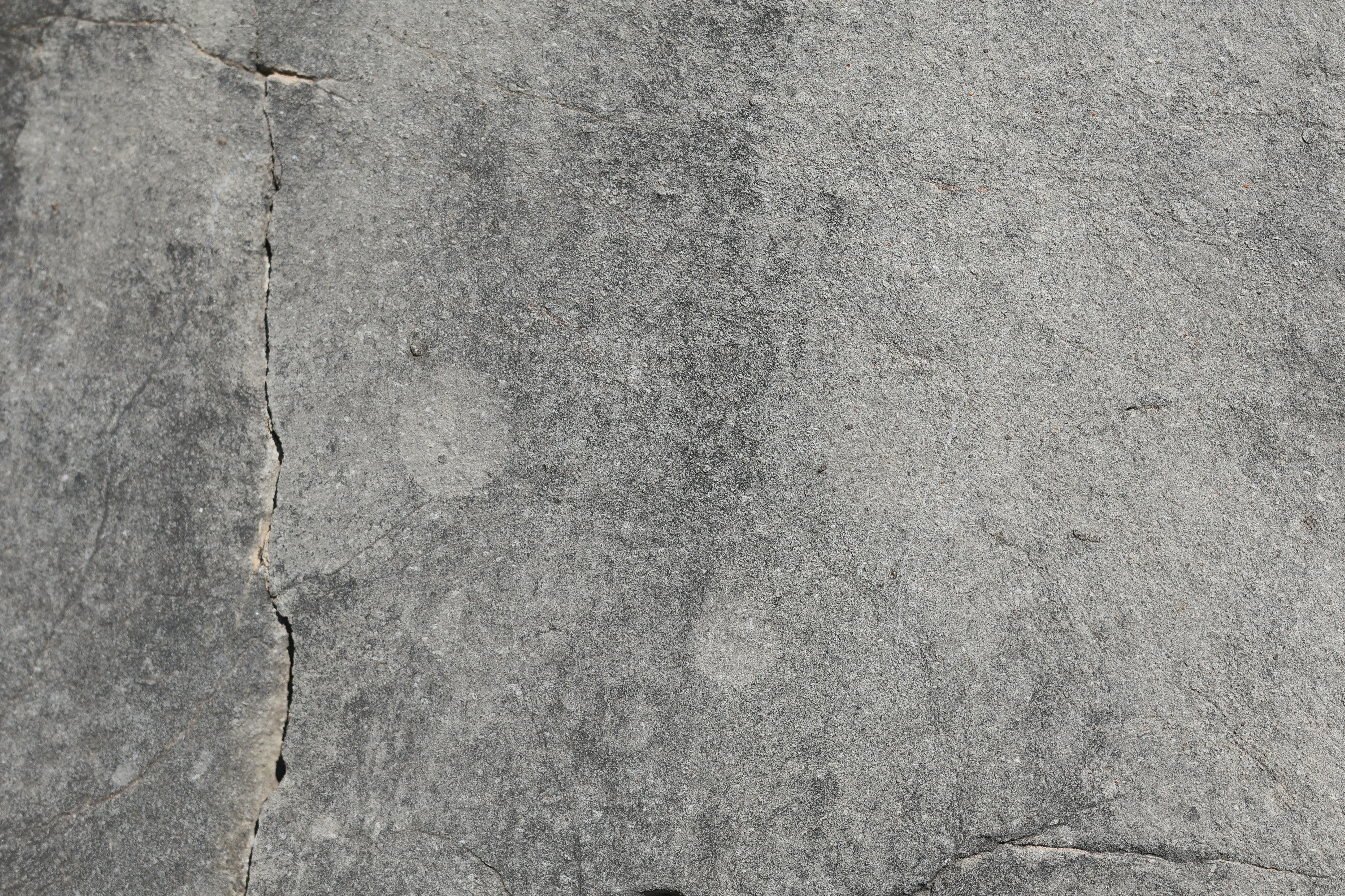 Weathered Concrete: A Quiet Crack Running Through Gray Stone
