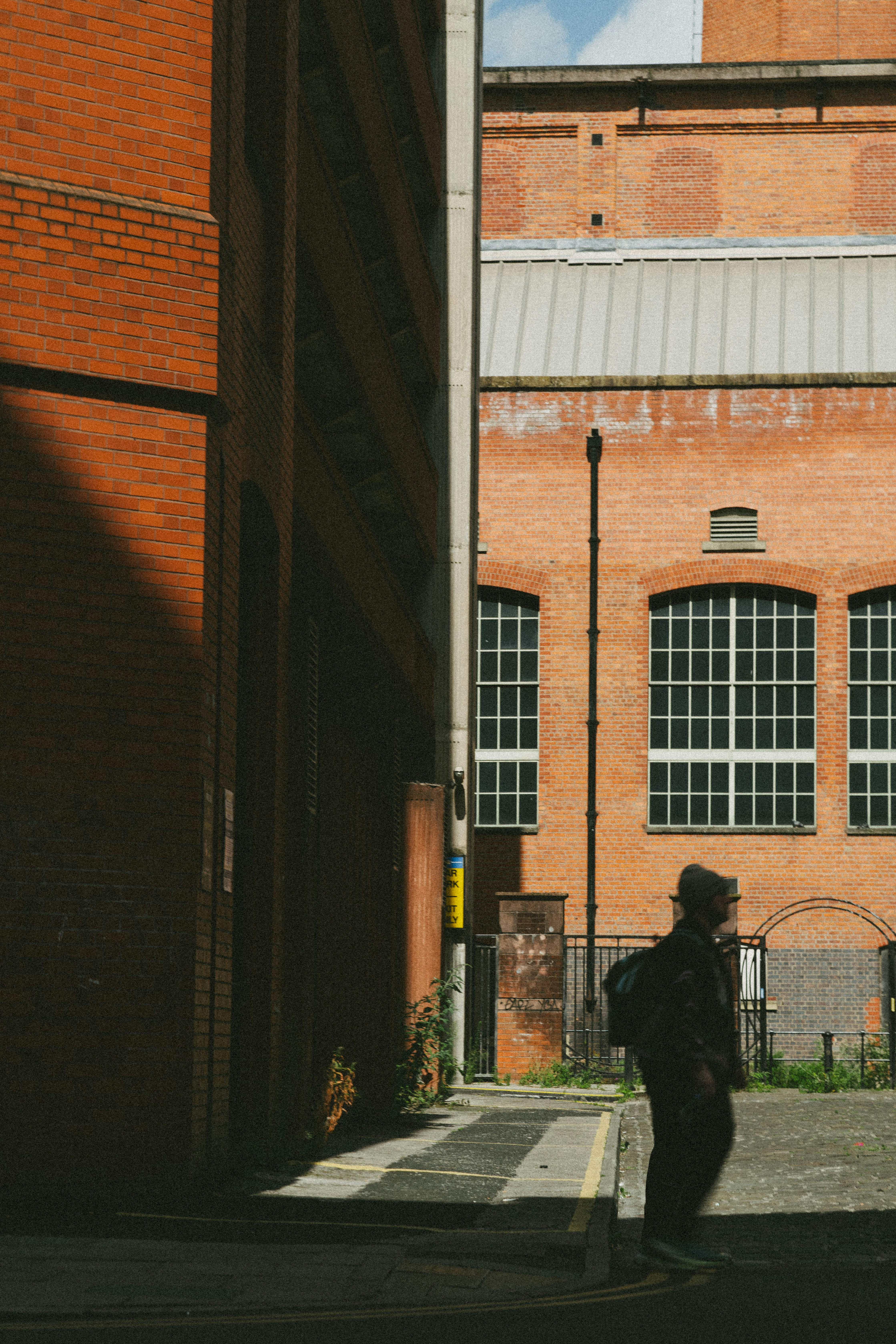 Shadow runner in the brick-lined alleyway