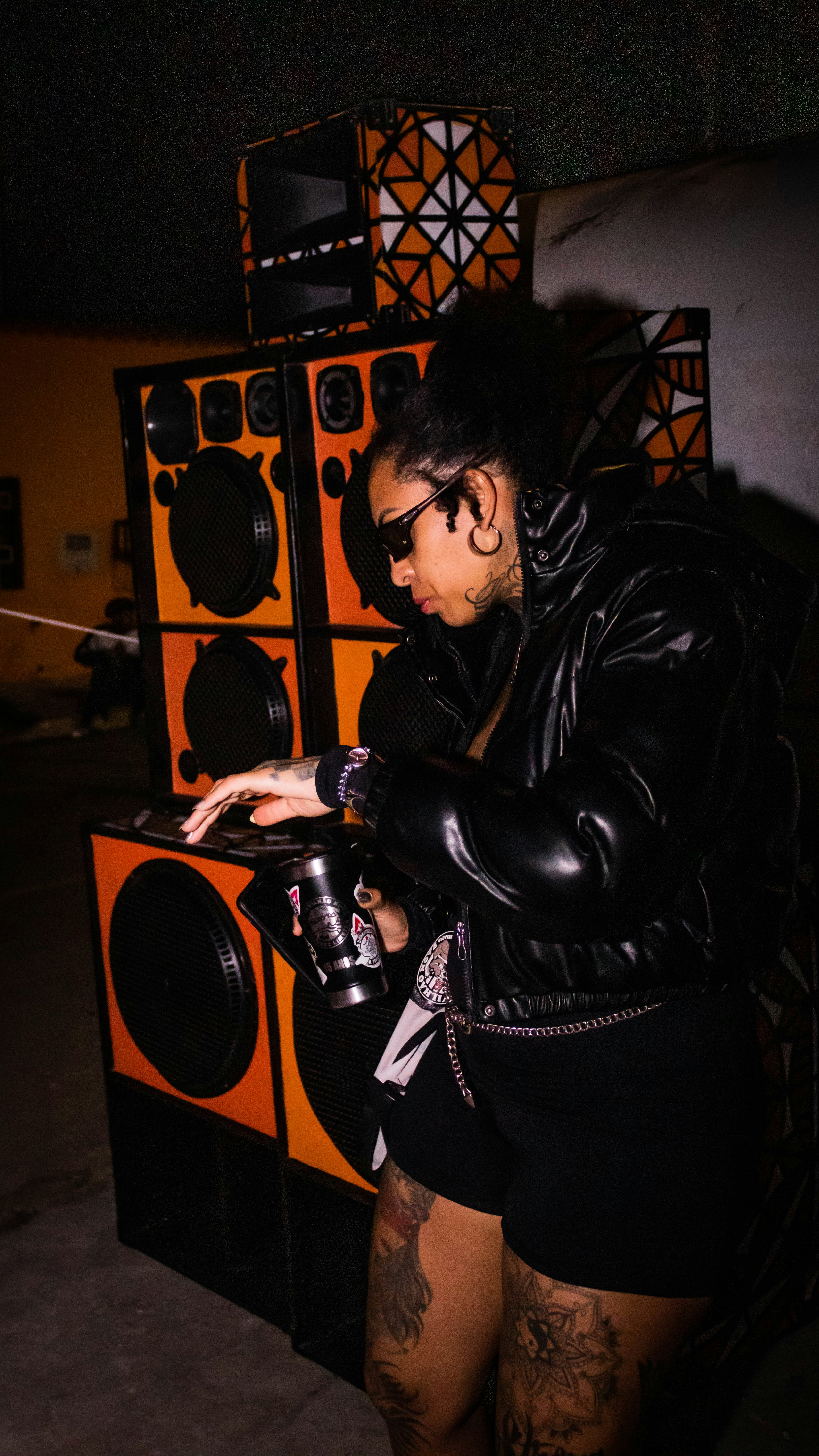 Midnight Vibe: DJ Booth and Tattoos in Neon Orange Boom
