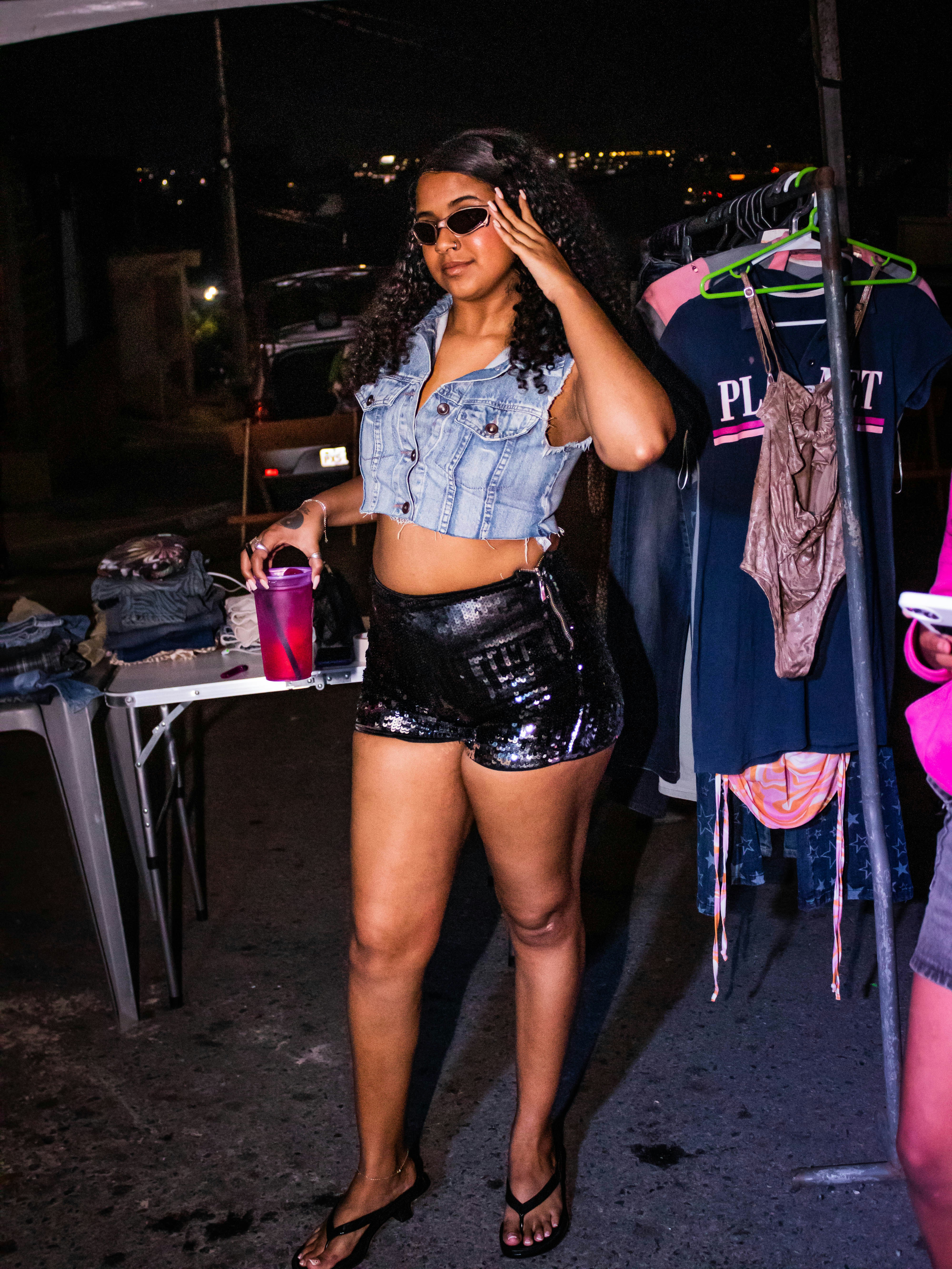 Spotlight on the Night Market: Confident Pose in Denim and Sequins