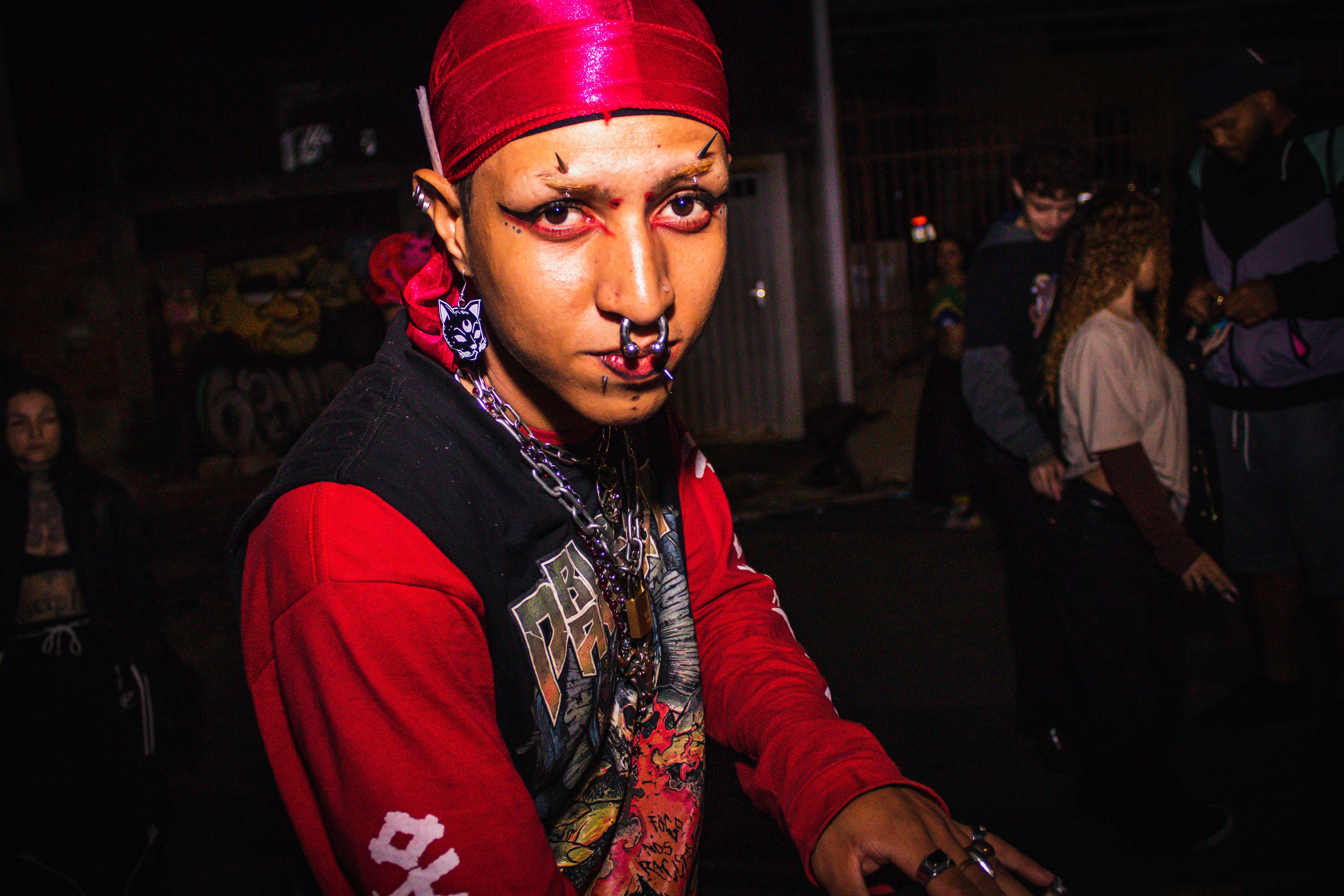 Bold Night Portrait: Piercing Gaze and Piercings Under Neon Lights