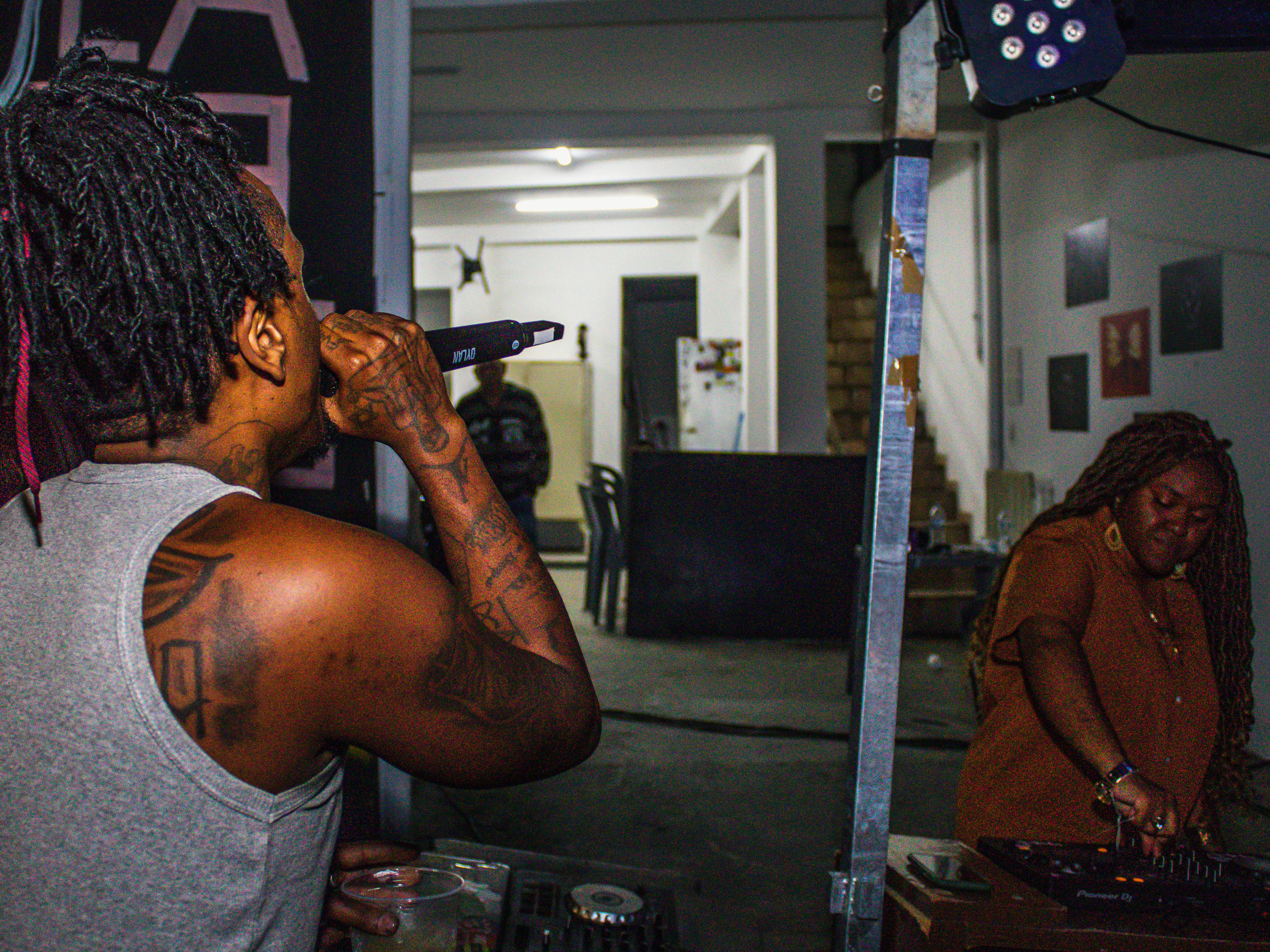 Microphone Moment: Performer in the Spotlight at a Dim Studio