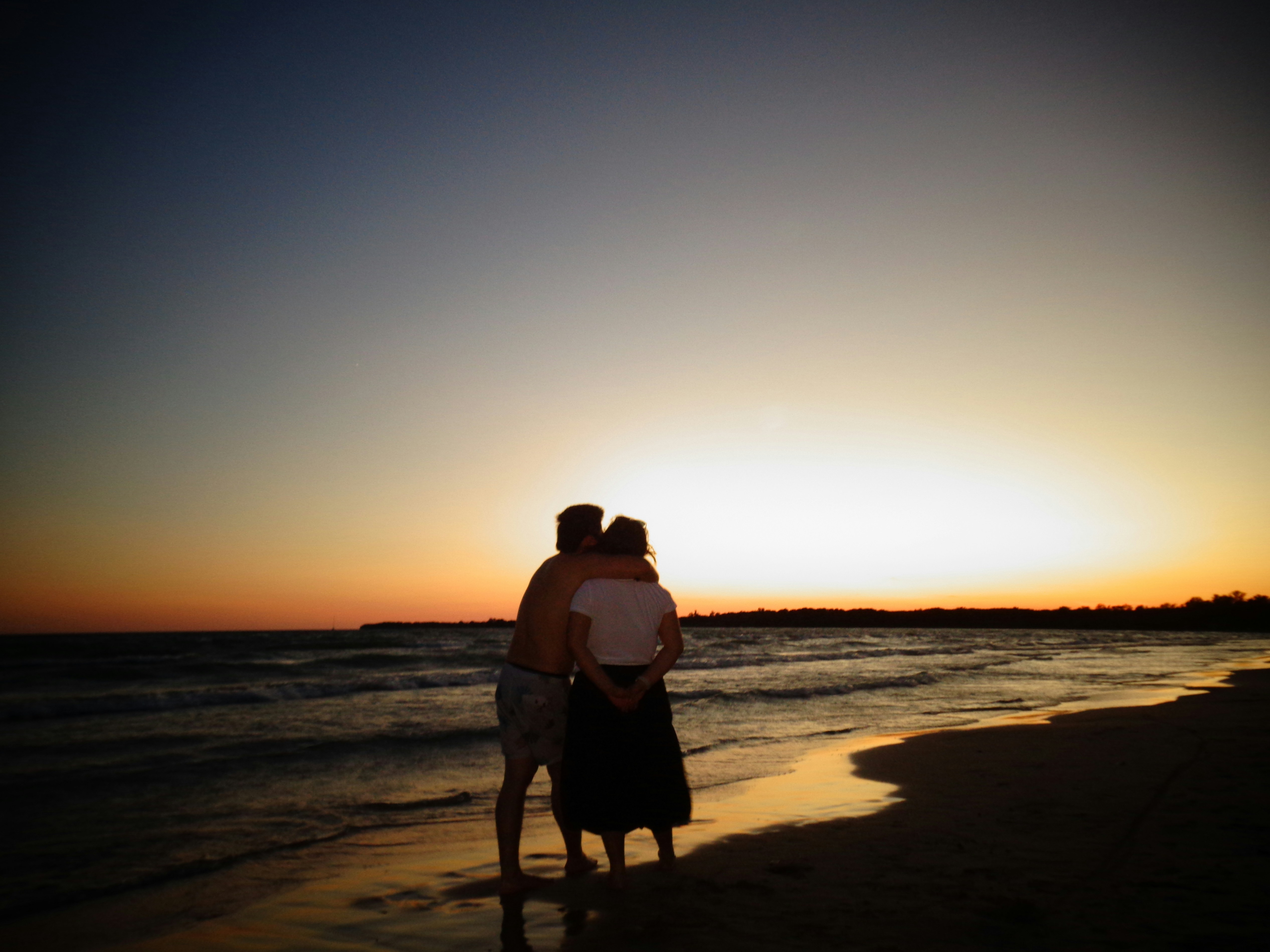 Couple at the Horizon: Embrace at Sunset on the Shore