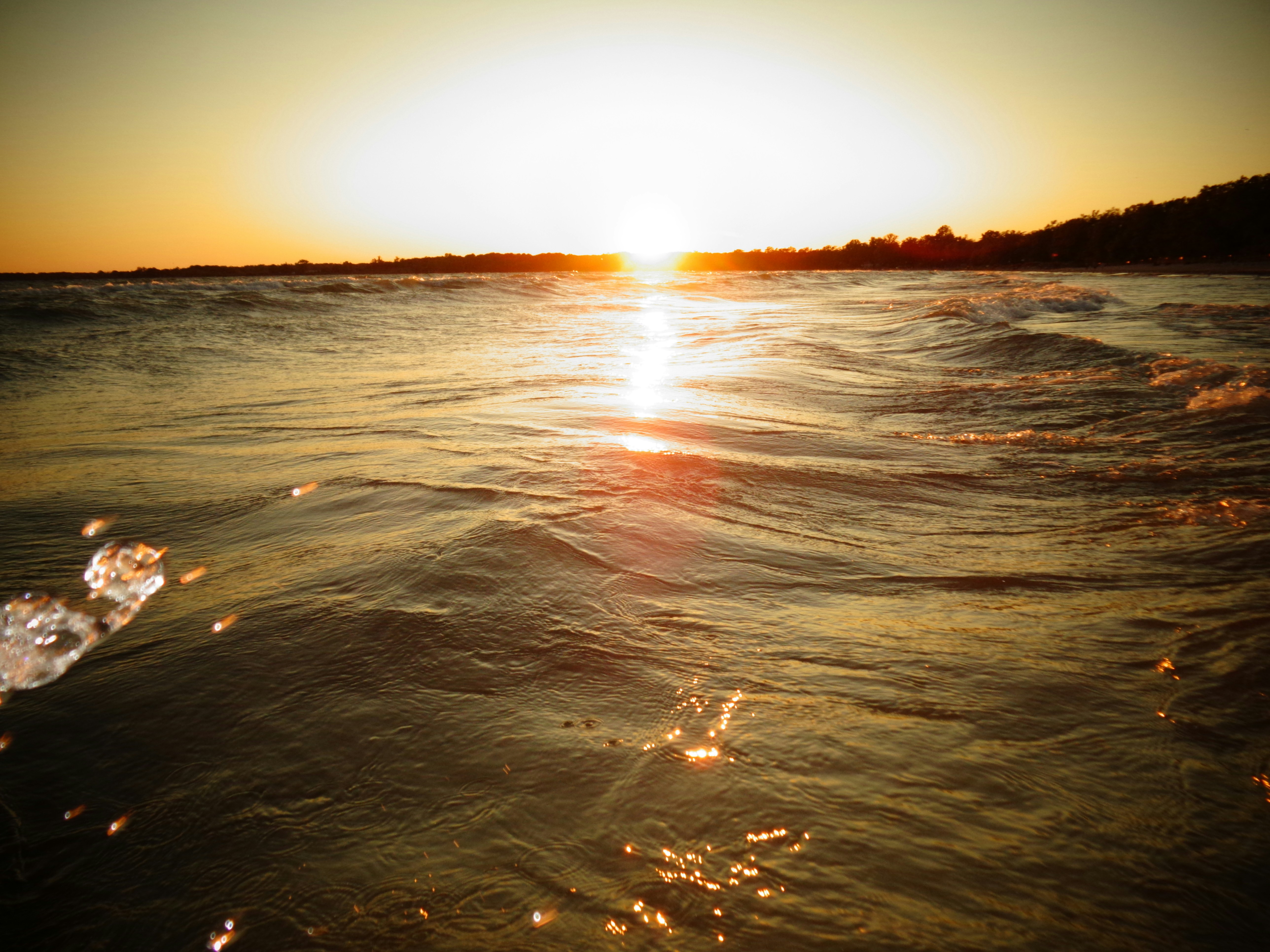 Sunlit Horizon Over Gentle Waves at Dusk