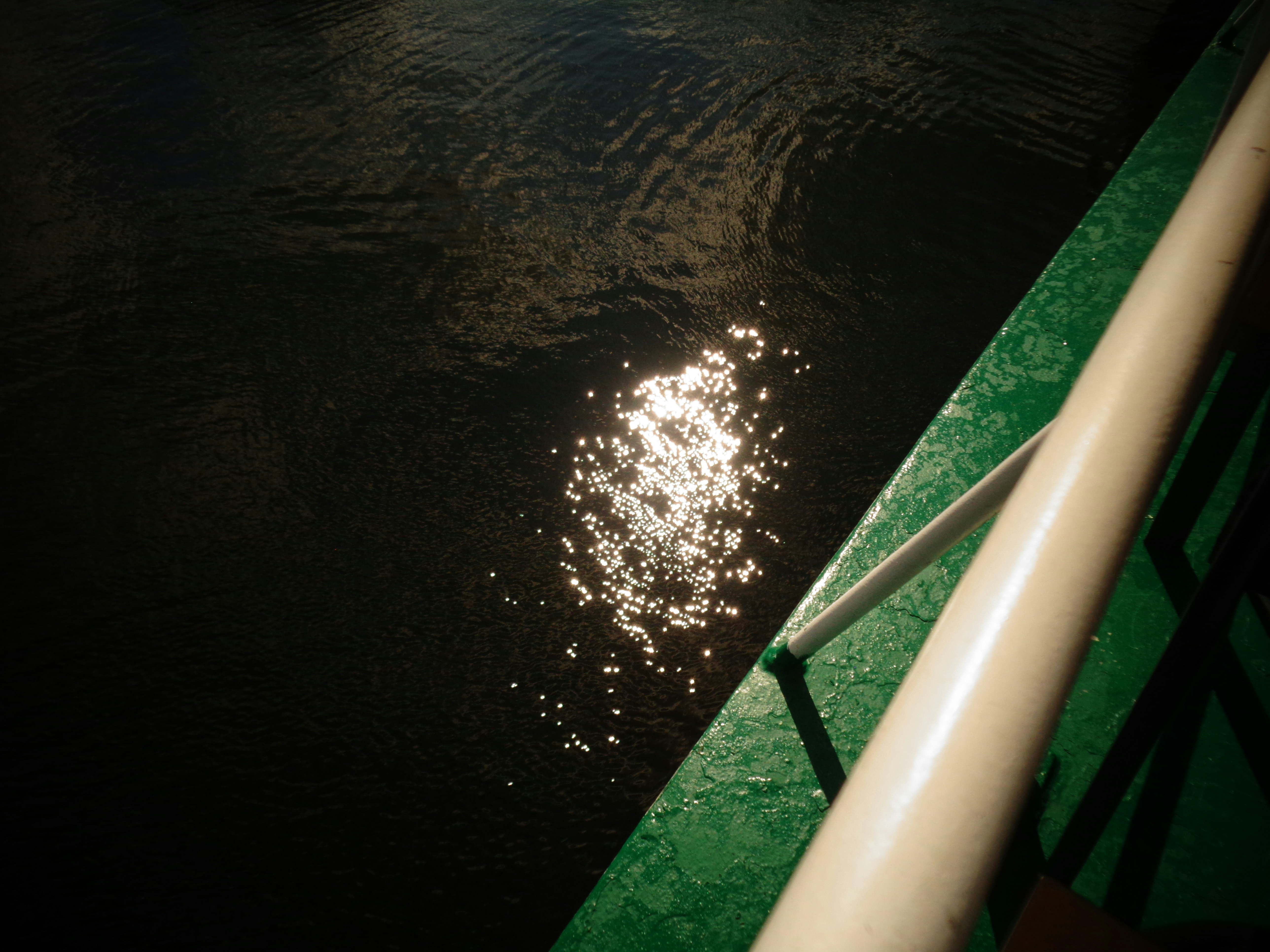 Glint on Water from a Ferry Rail